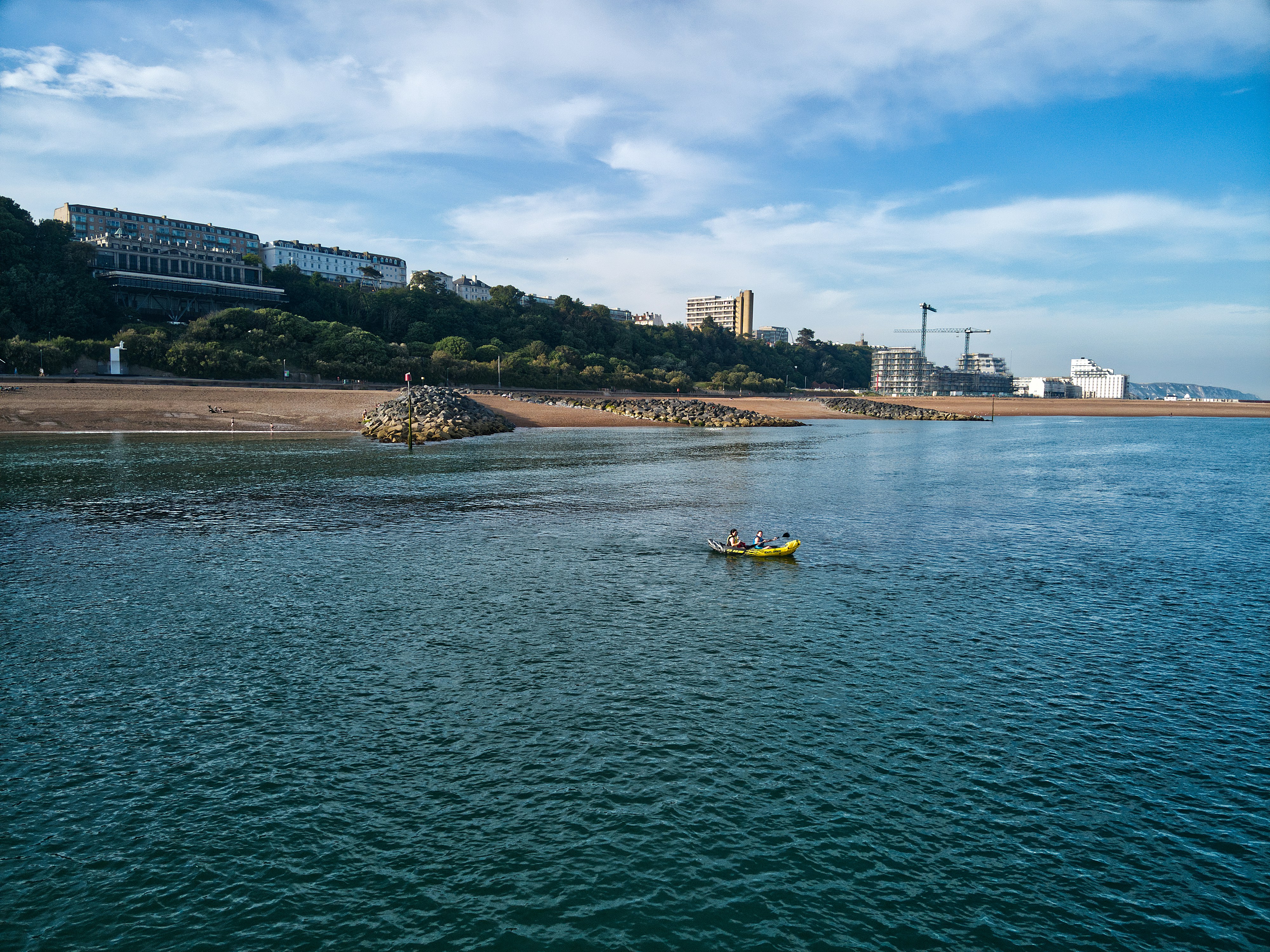 a body of water with boats in it and buildings in the background