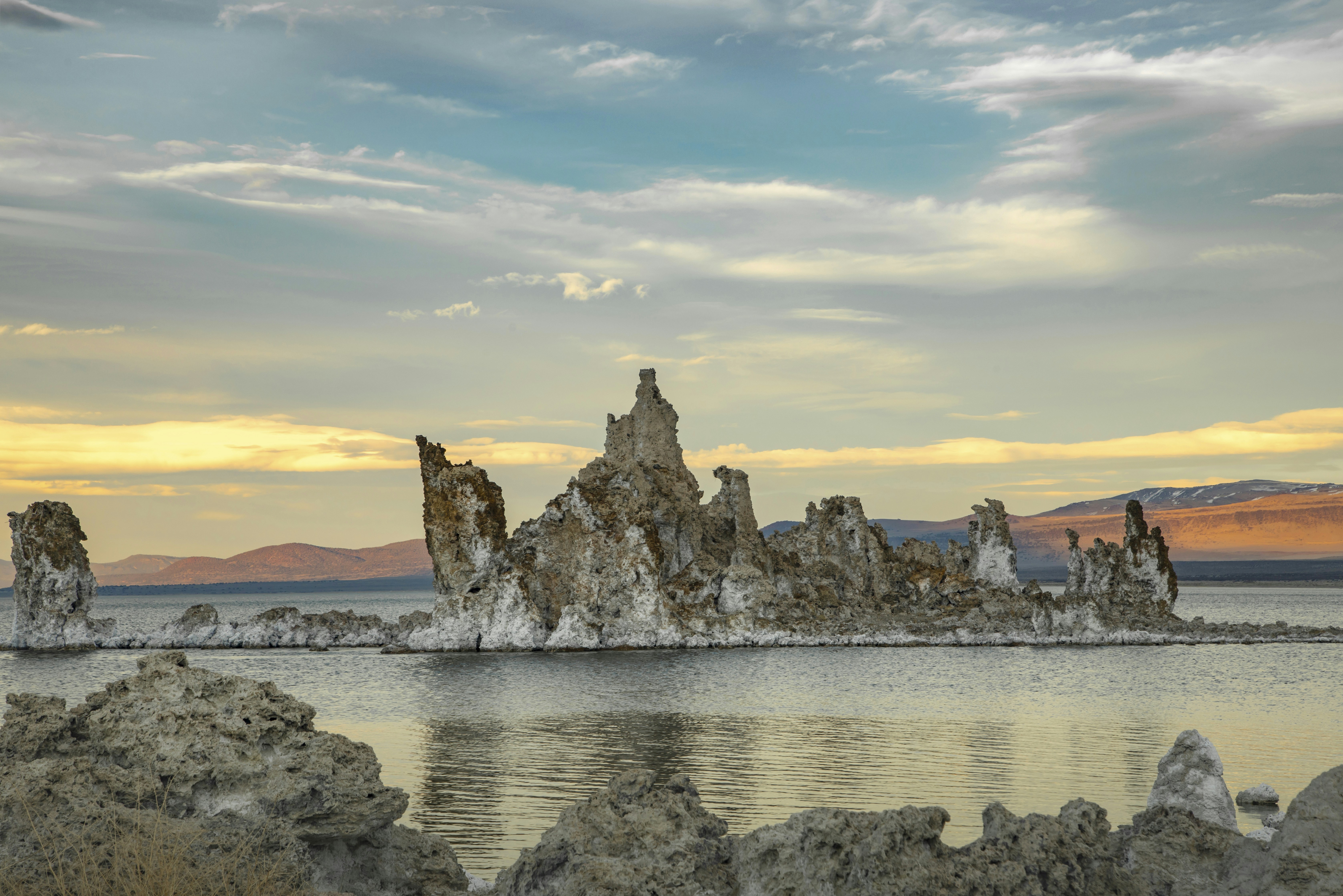 A body of water with large rocks in it and a group of large rocks in ...