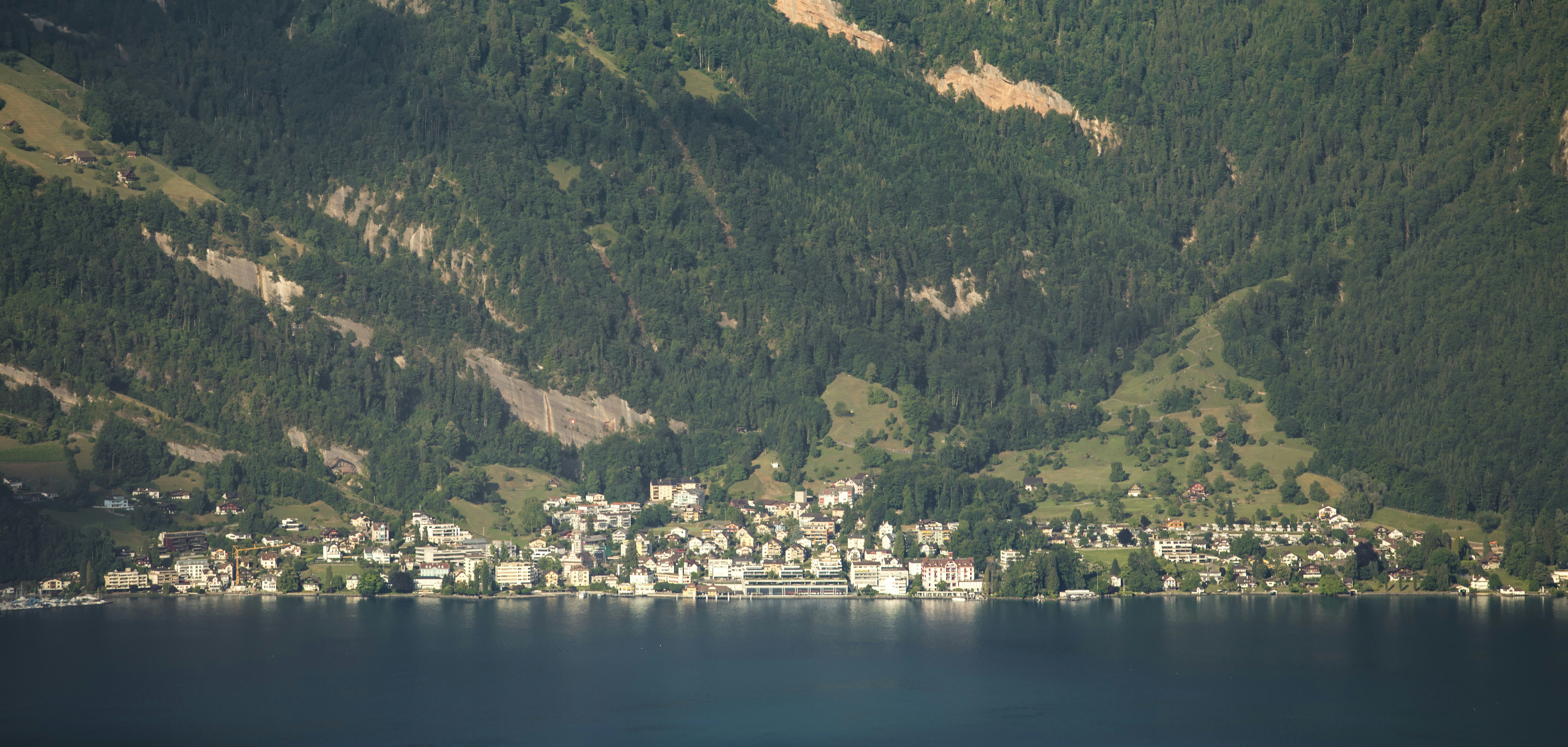 Tranquil Lakeside Village Amidst Majestic Mountains