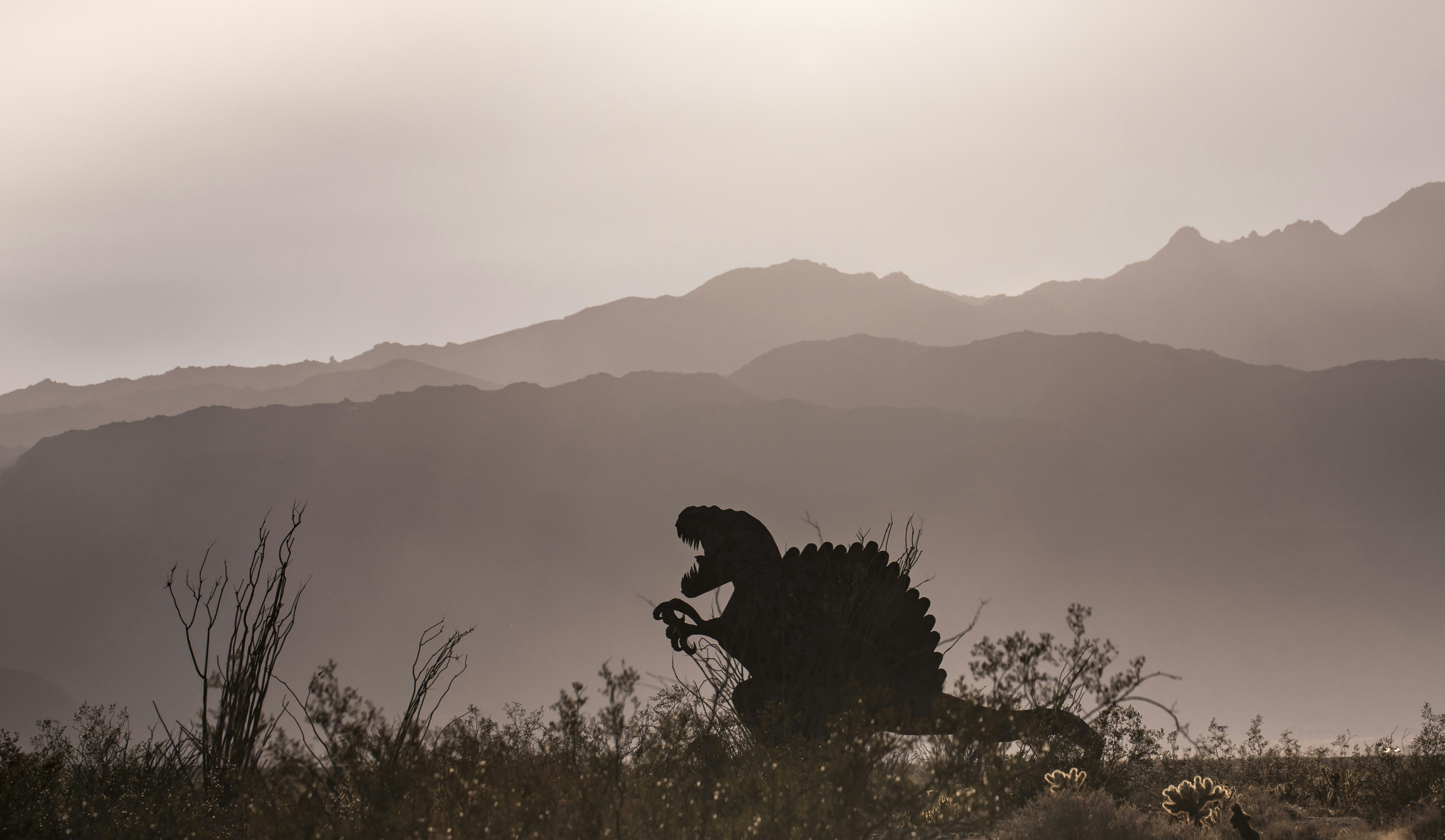 Stegosaurus Silhouette Over a Desert Ridge at Dusk