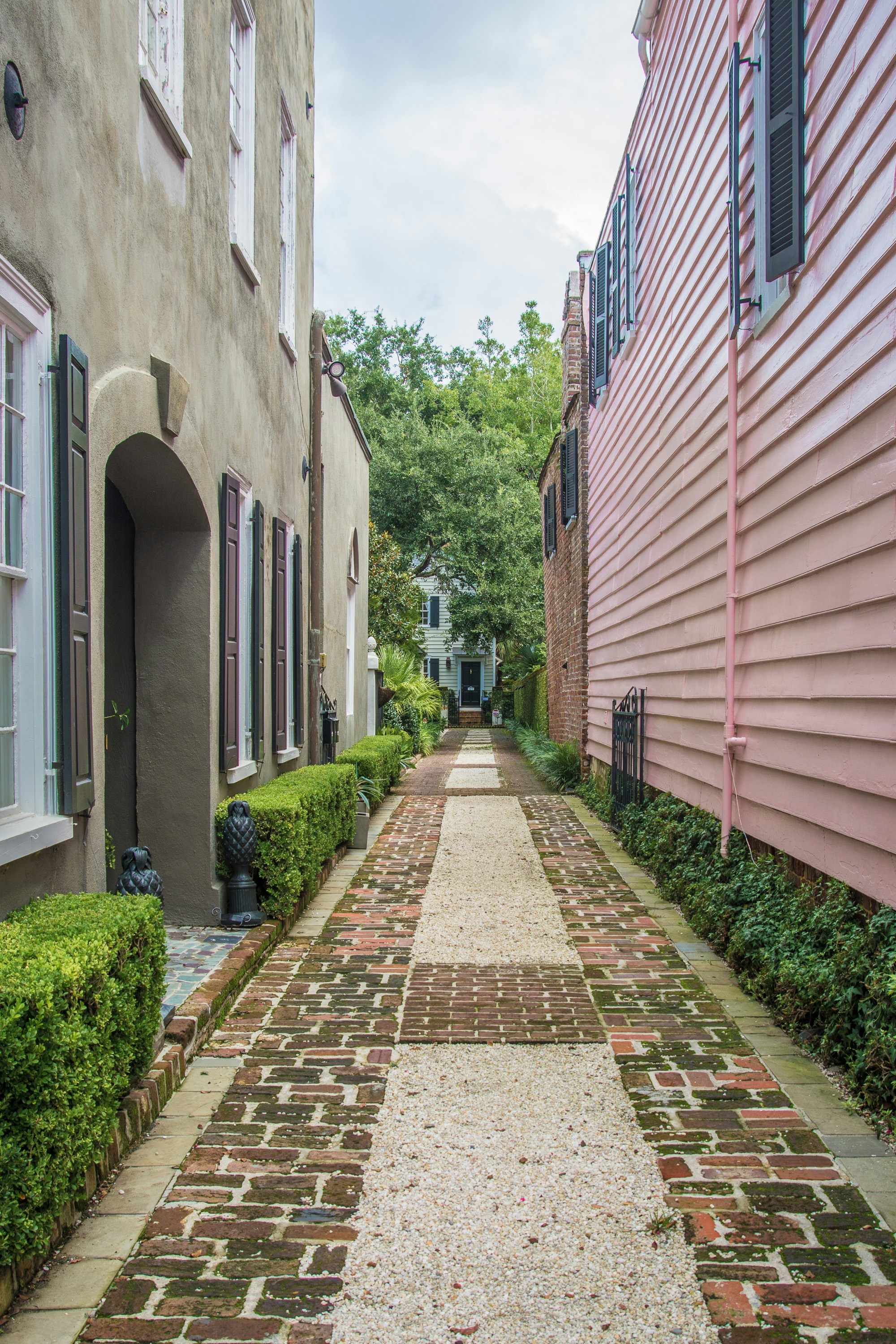 A brick path between buildings photo – Free Street Image on Unsplash