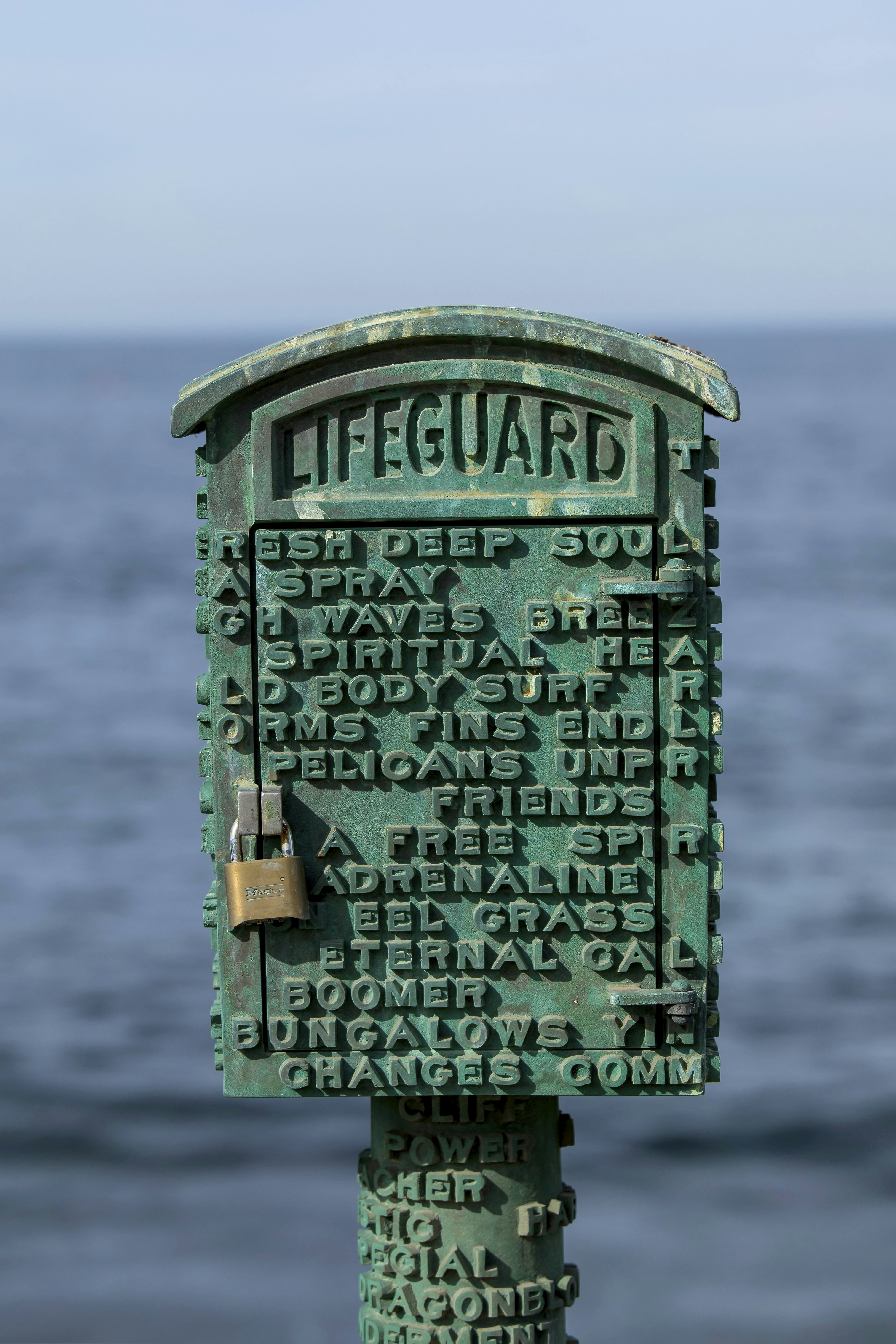 Salt-Washed Sentinel: Weathered Lifeguard Cabinet by the Sea