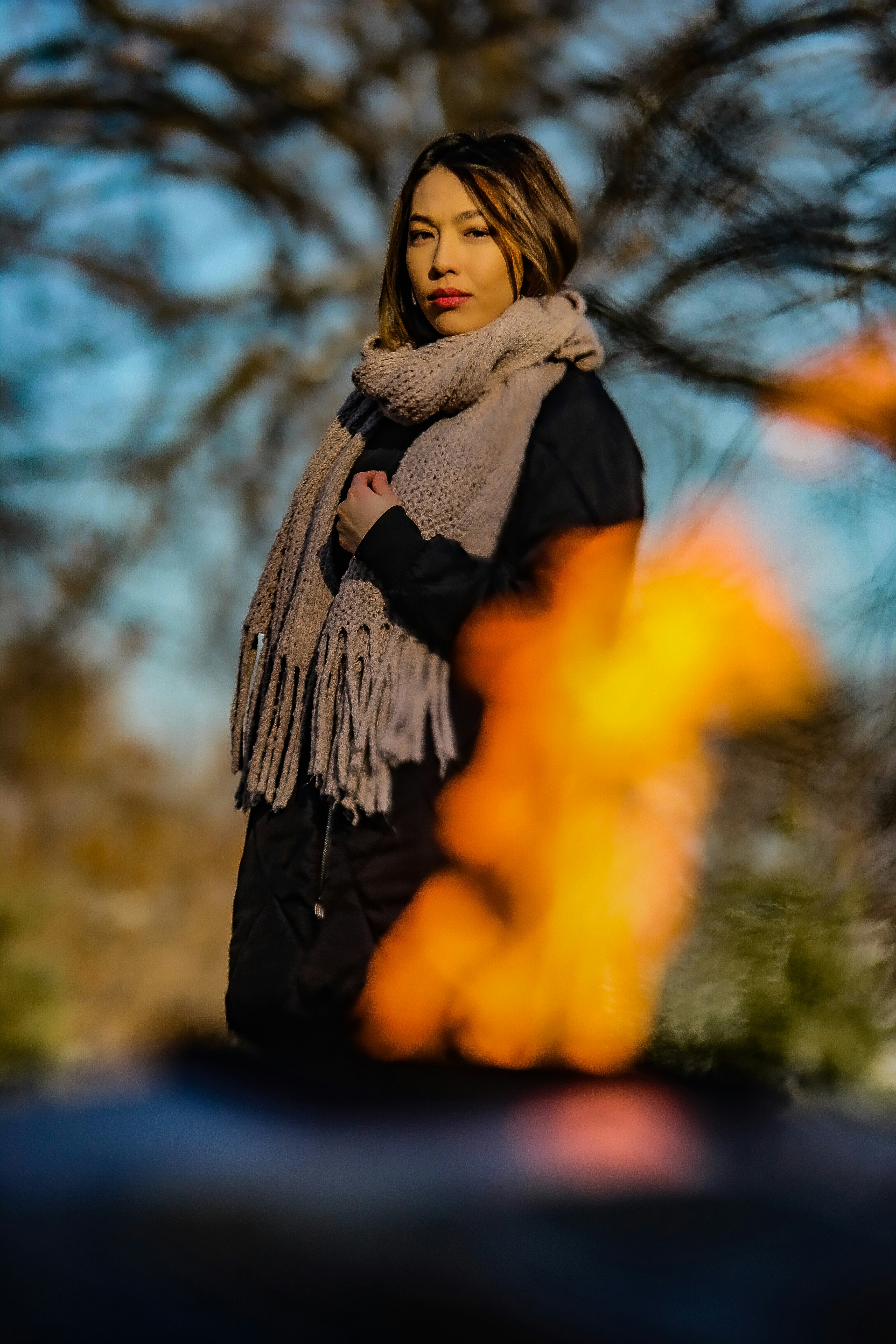 Wrapped in Warmth: A Quiet Portrait Against Autumn Bokeh