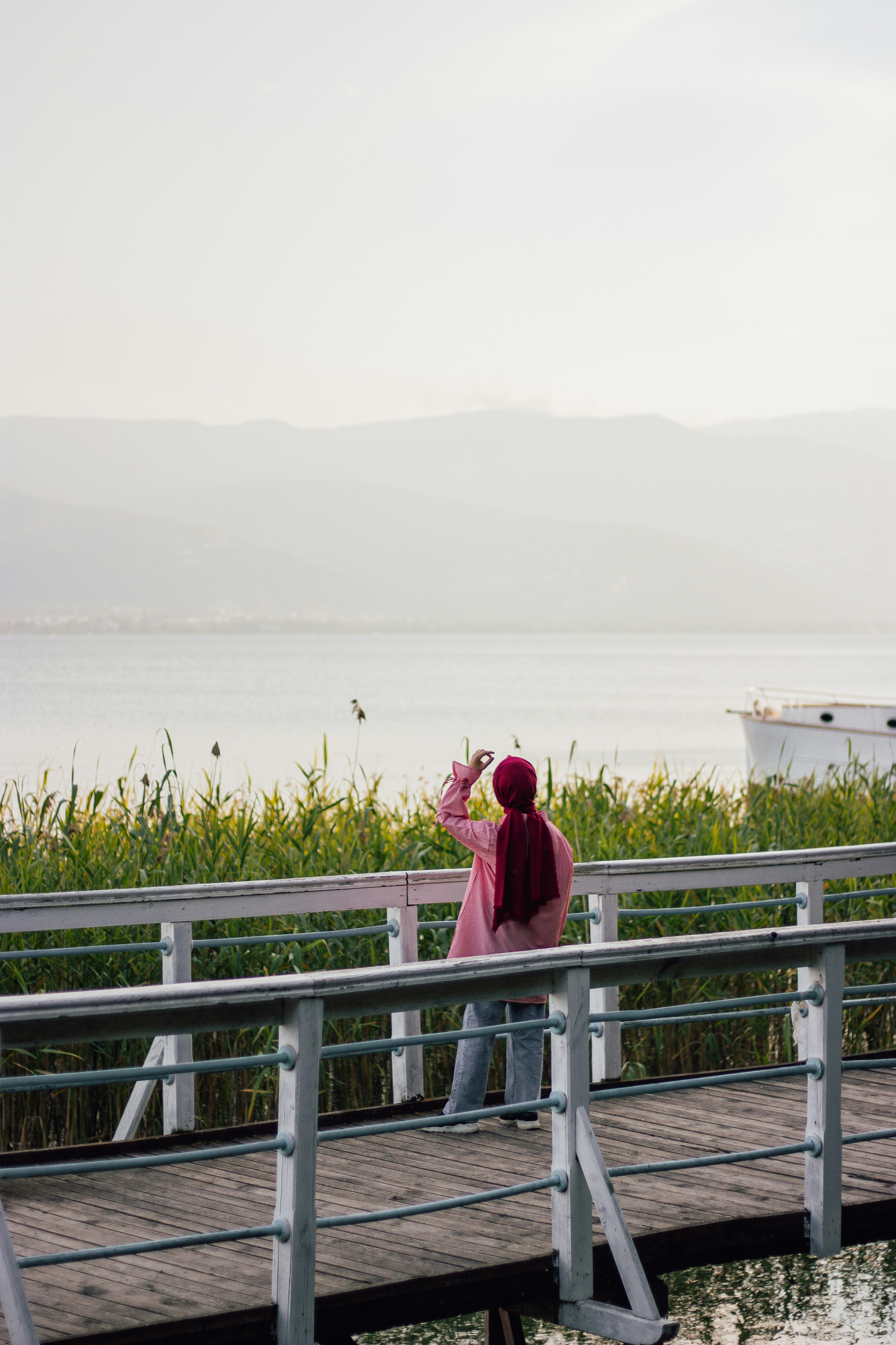Pink Hijab by the Riverside: A Quiet Wave on the Pier