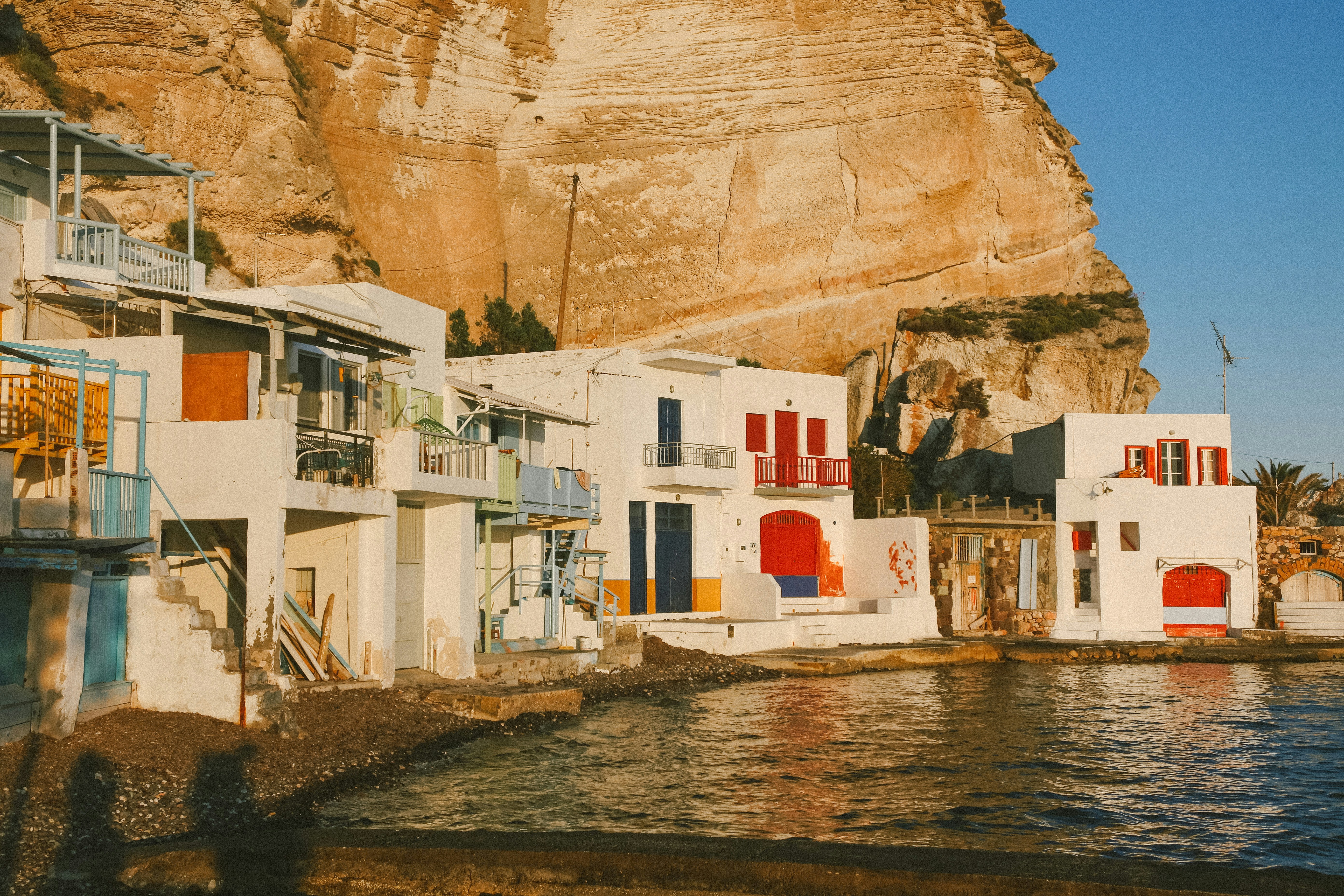 A row of buildings next to a body of water photo – Free Klima Image on ...