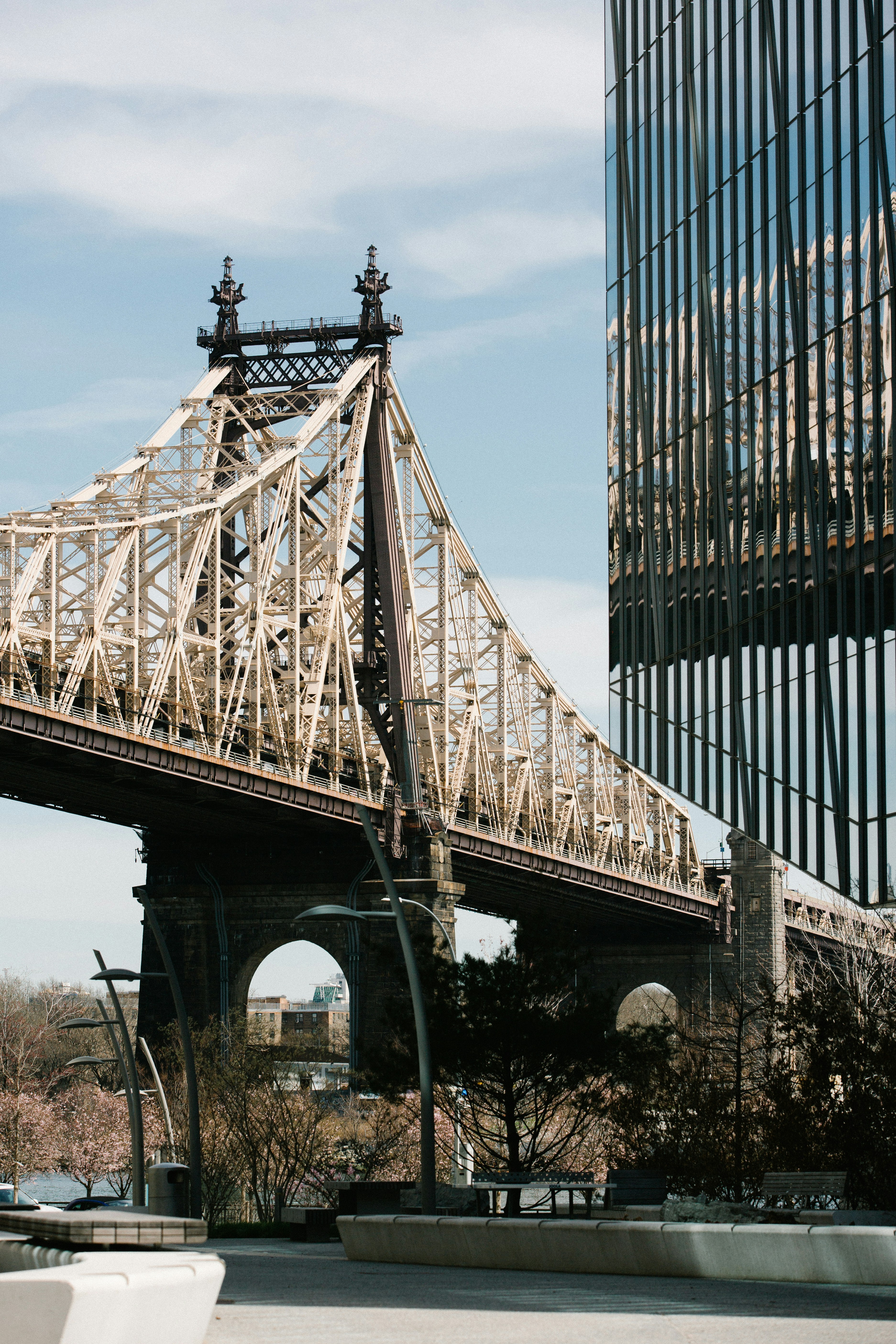 A large metal bridge with Queensboro Bridge in the background photo ...