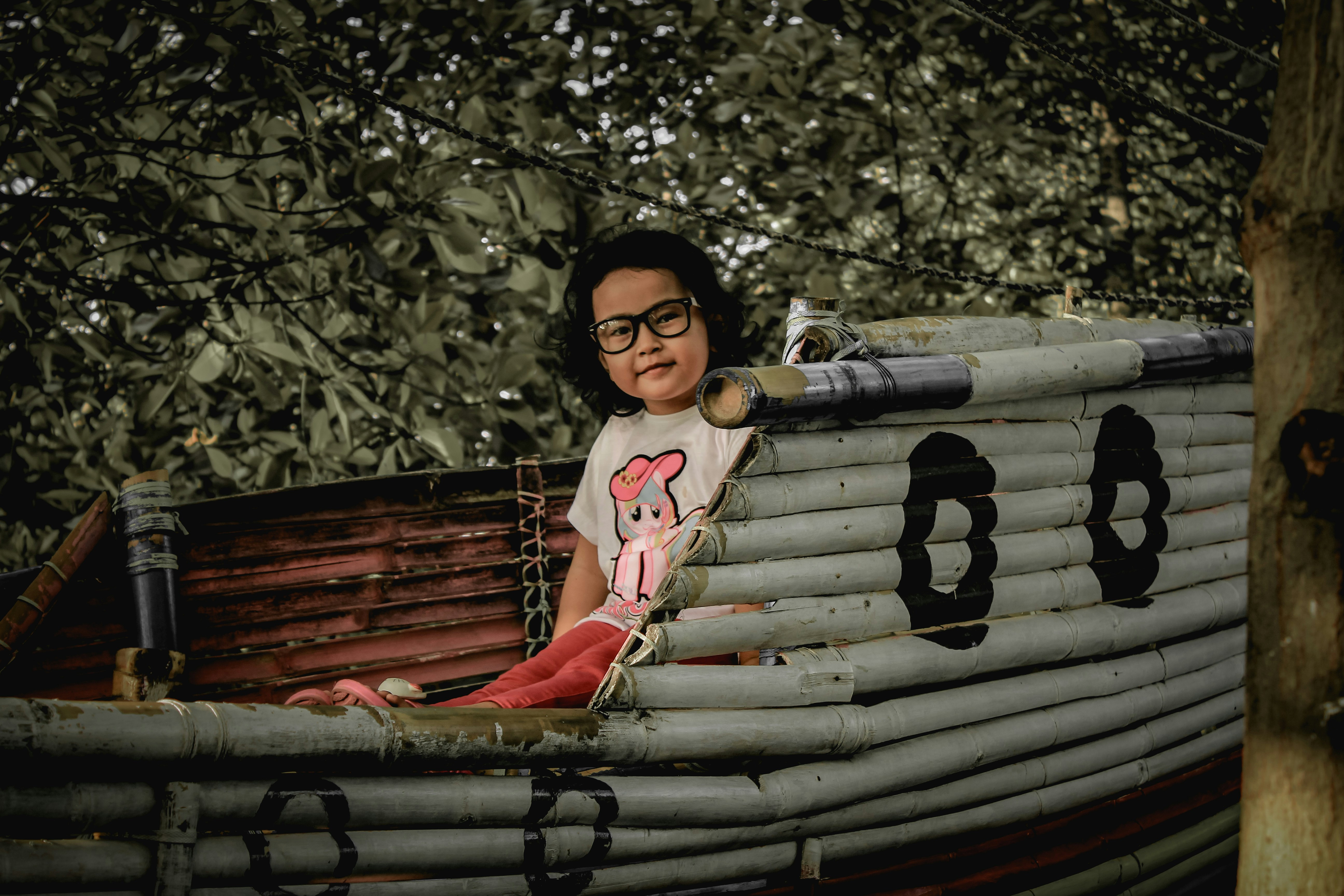 Glasses at the Helm: Portrait in a Bamboo Boat