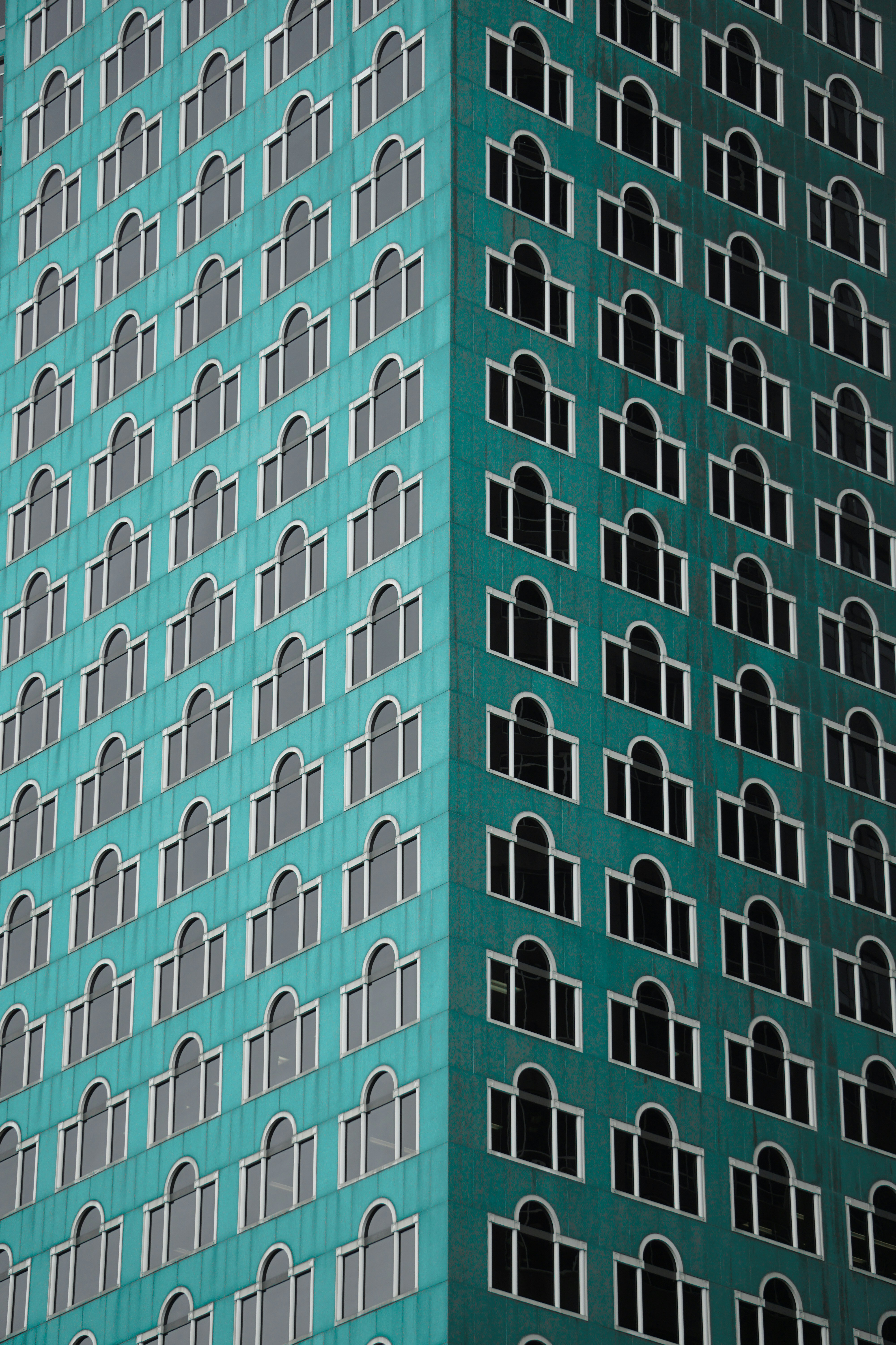 Corner of Teal Rhythm: A Grid of Arched Windows