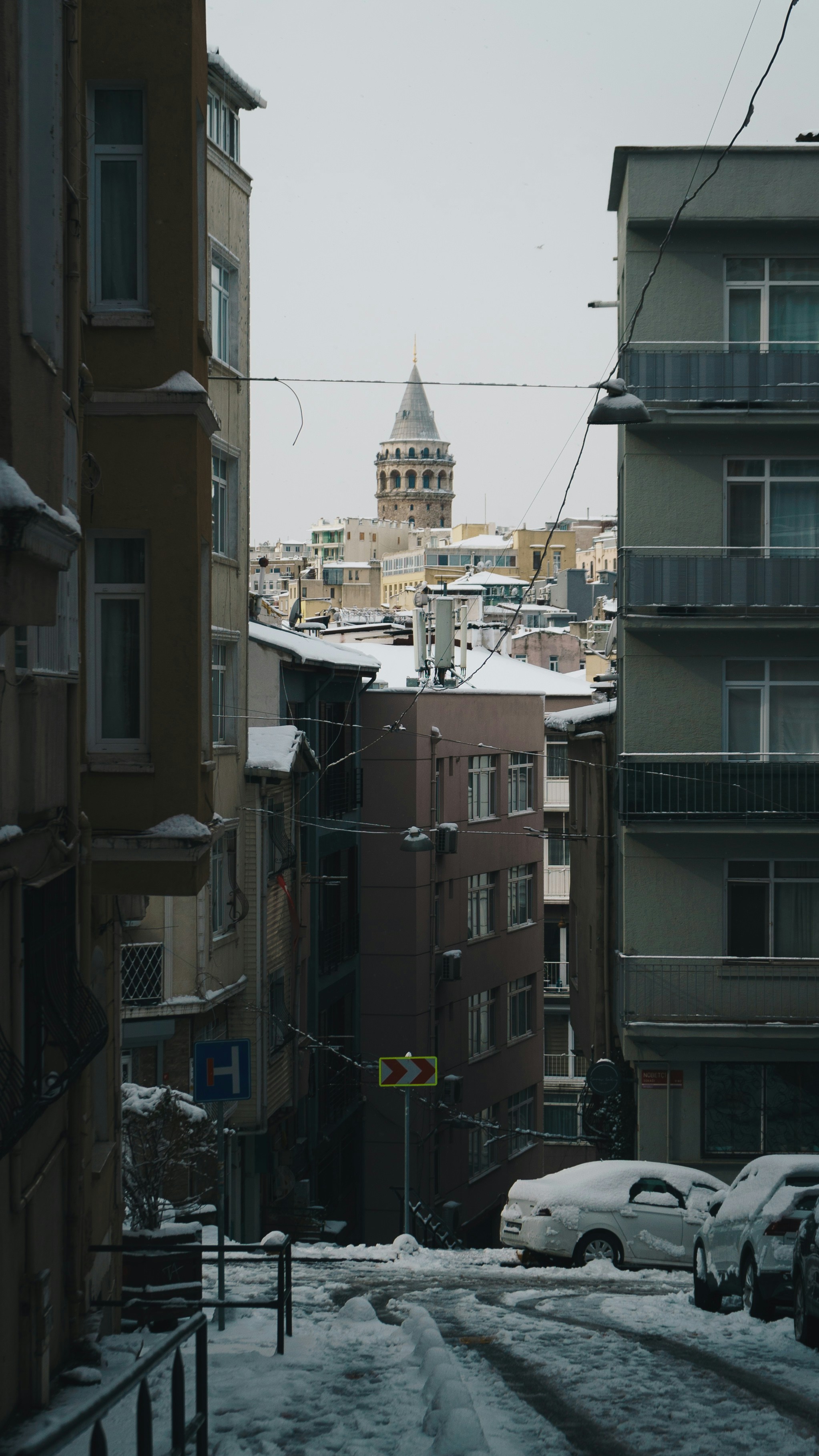 Snow-Blanketed Street Narrows Toward Istanbul’s Galata Tower