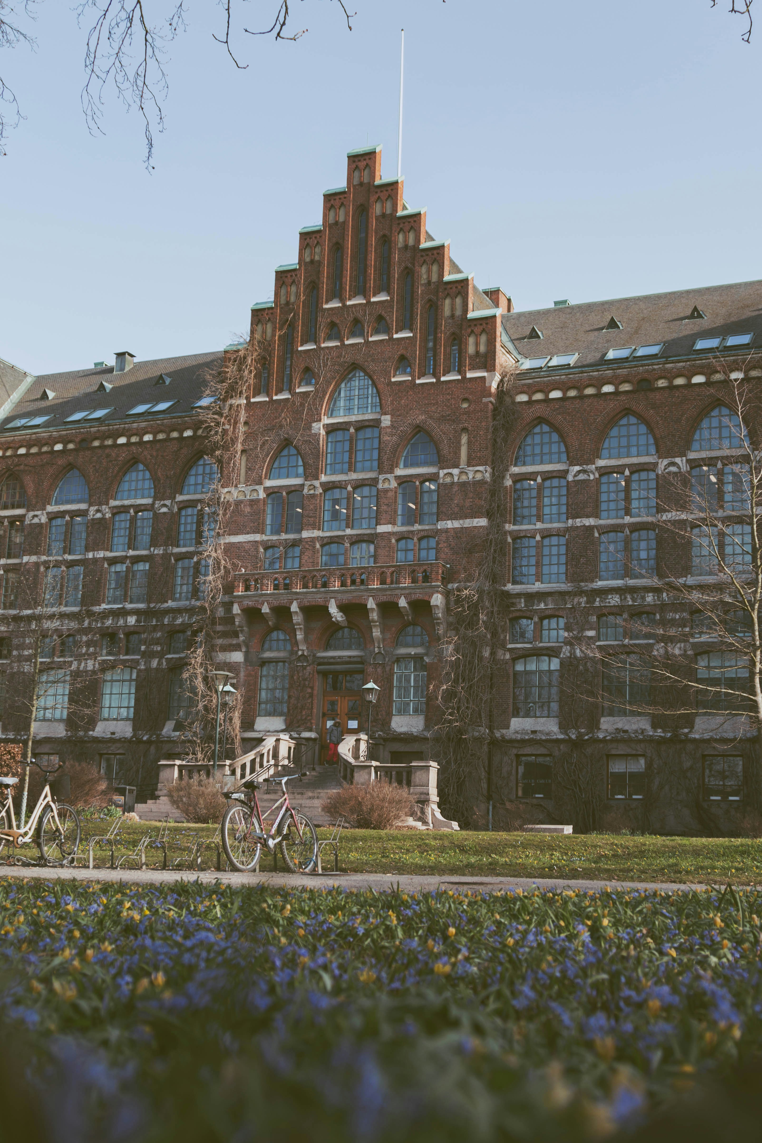 Gabled Brick Campus Rising Over a Quiet Foreground of Bikes