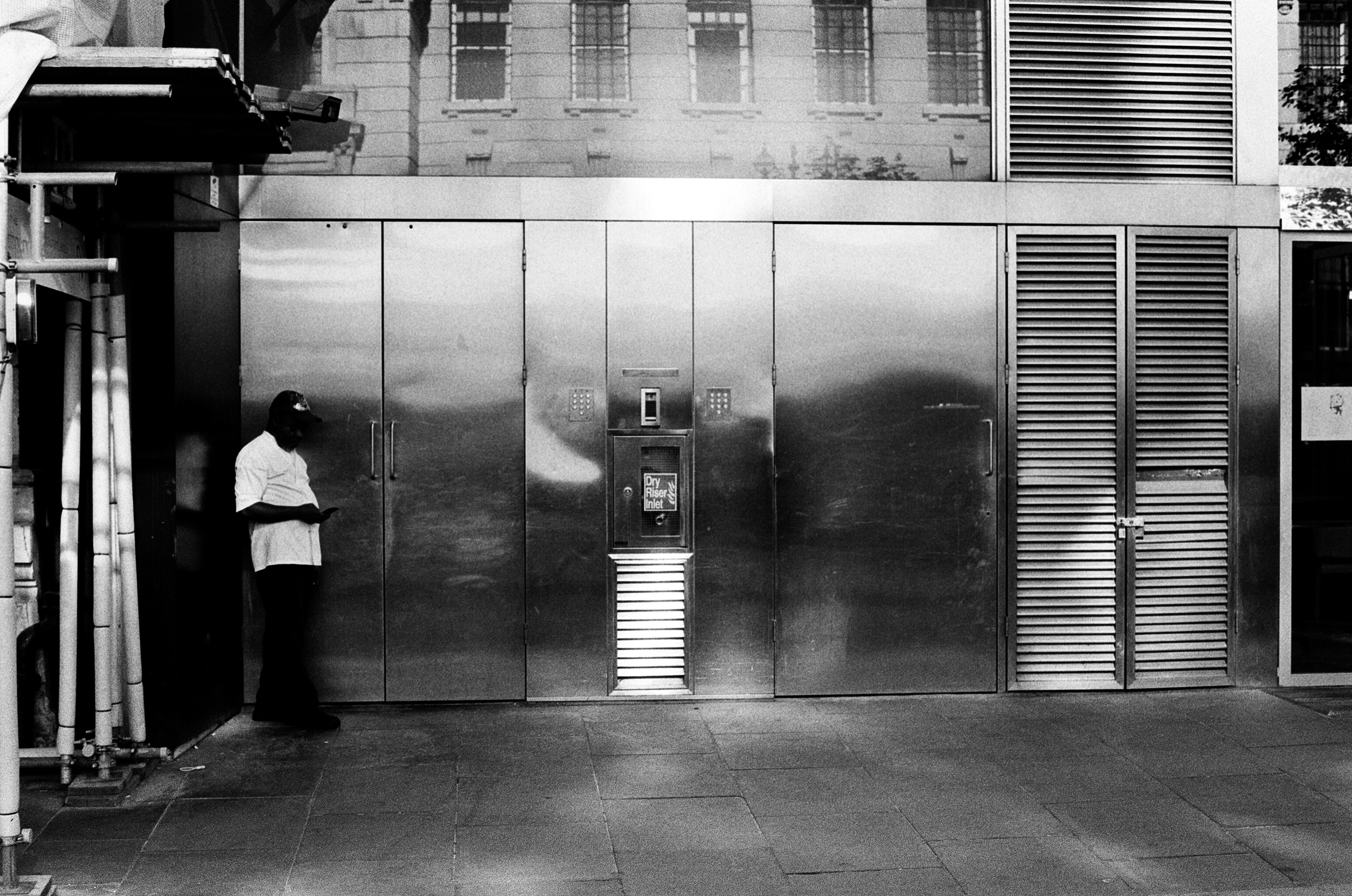 A person standing next to a row of lockers photo – Free Grey Image on ...