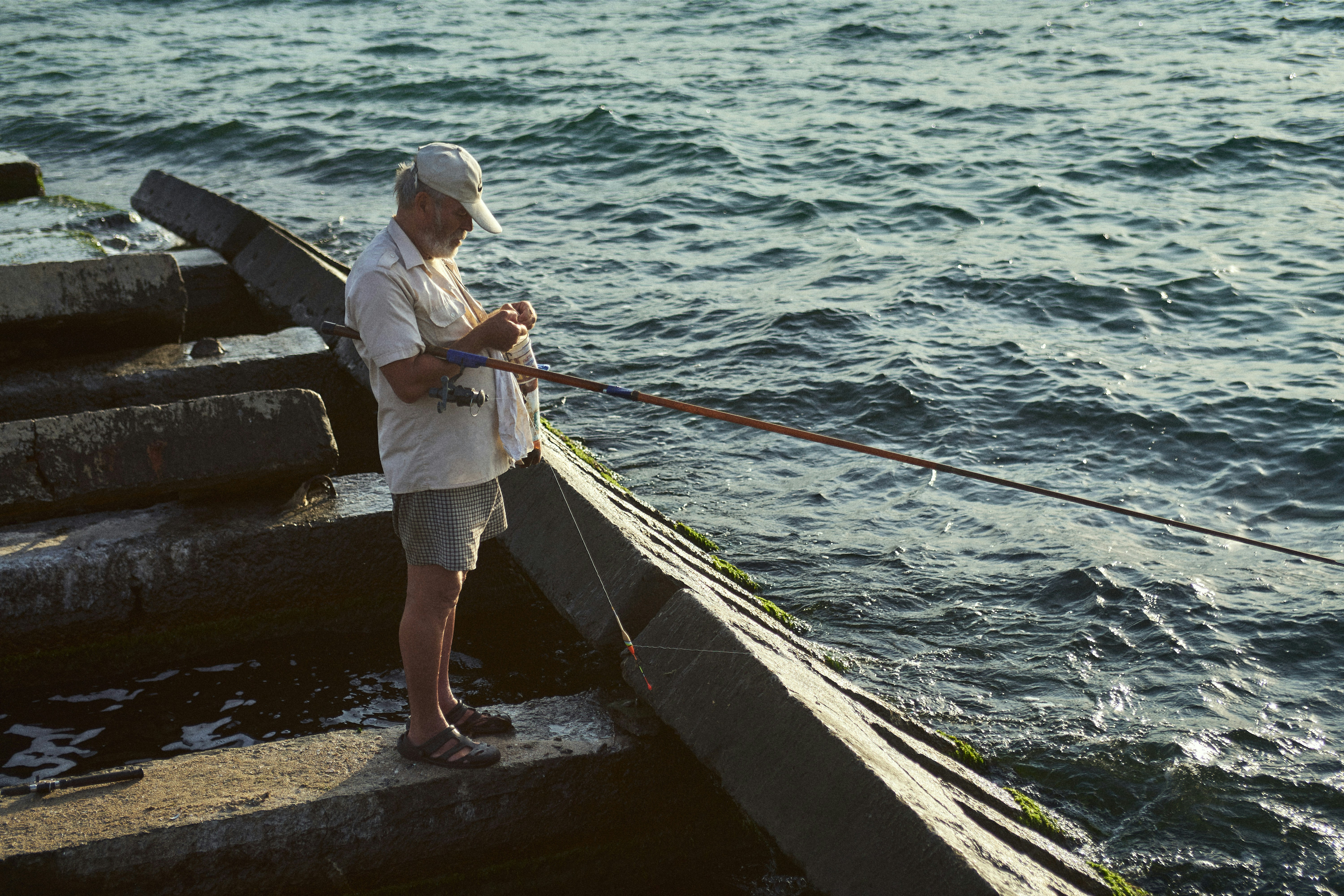 A person fishing on a pier photo – Free Fishing Image on Unsplash
