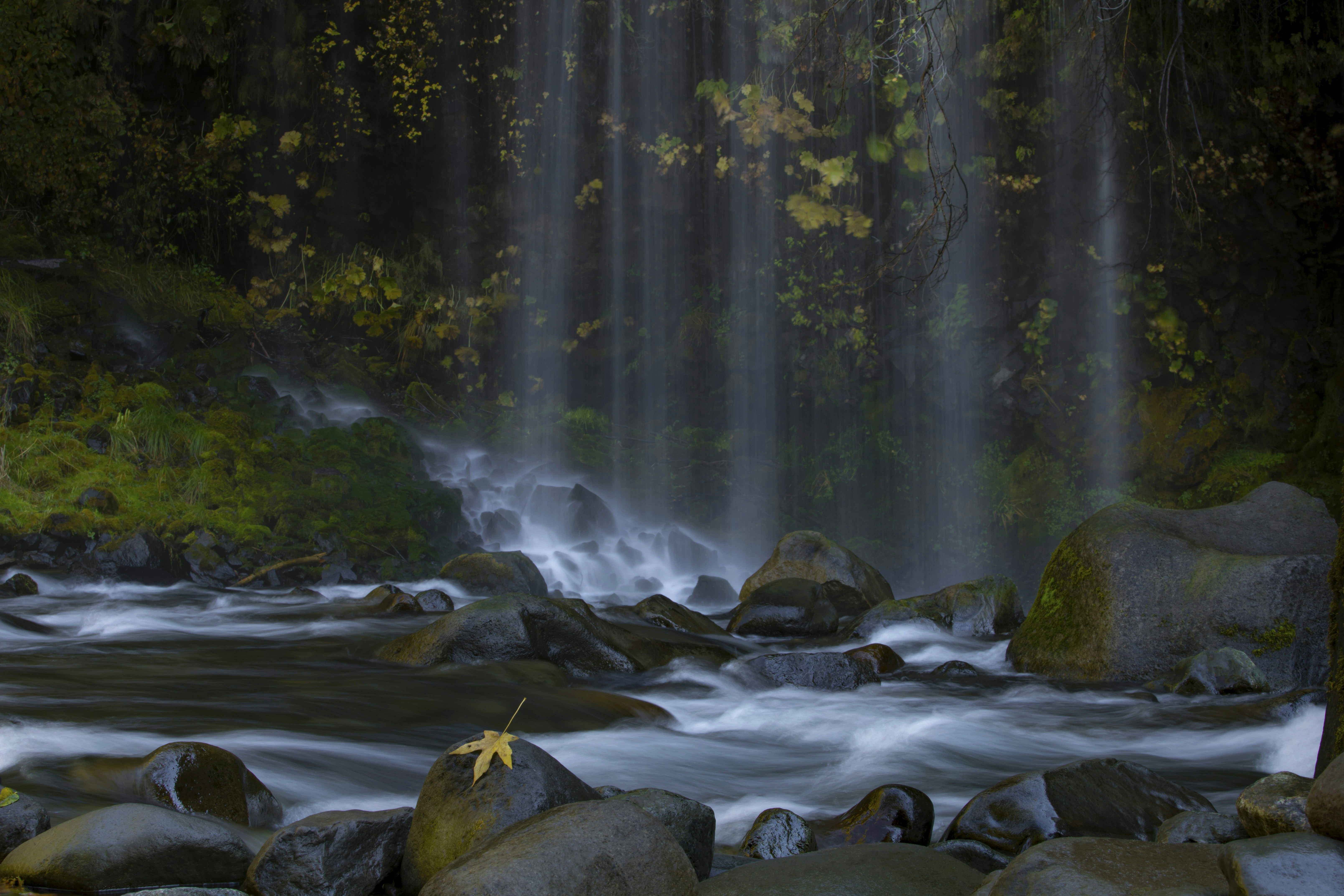 A waterfall with rocks and a fire photo – Free Grey Image on Unsplash