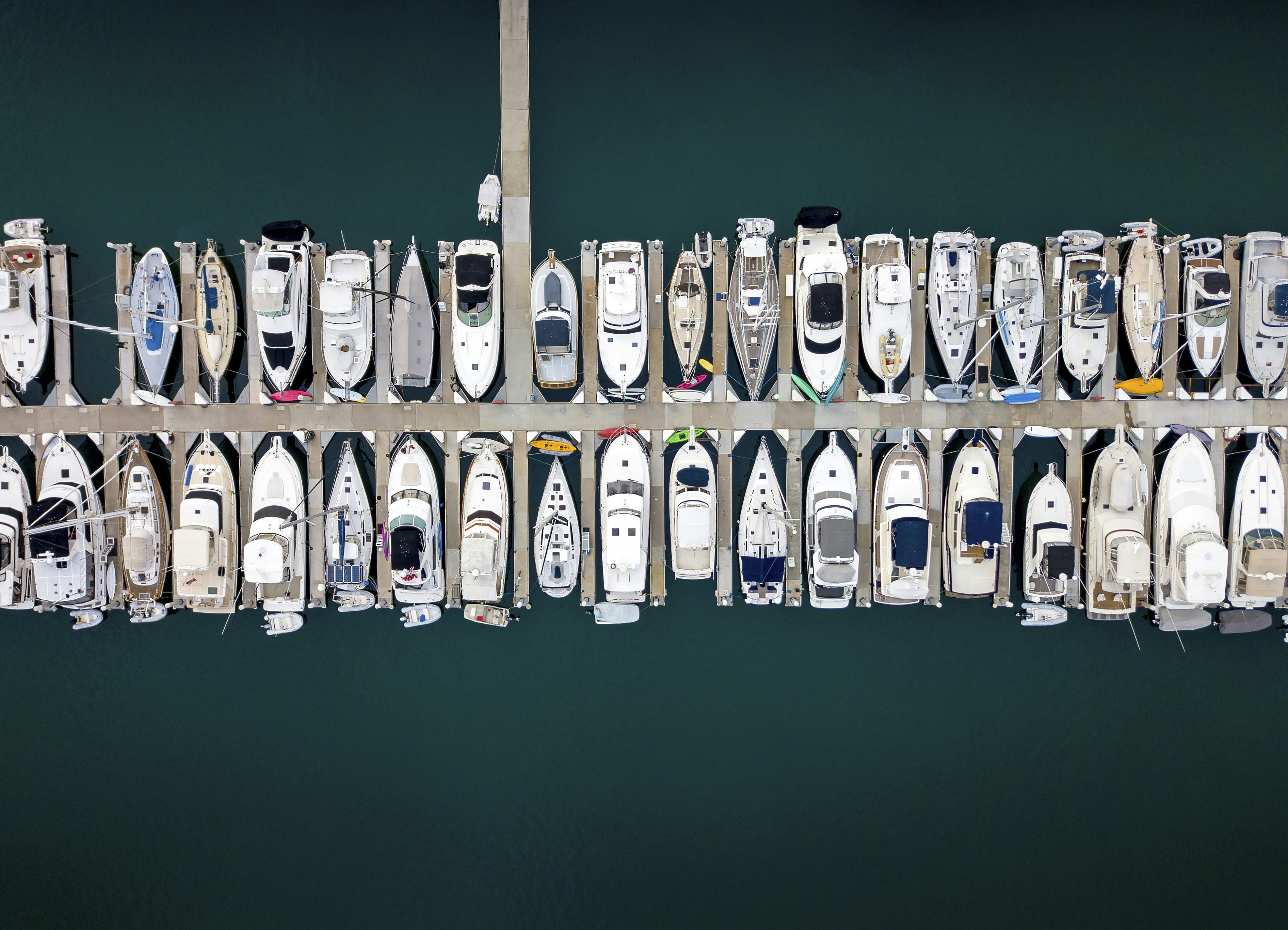 Marina Avenue: A Row of Docked Boats in Sea-Blue Calm
