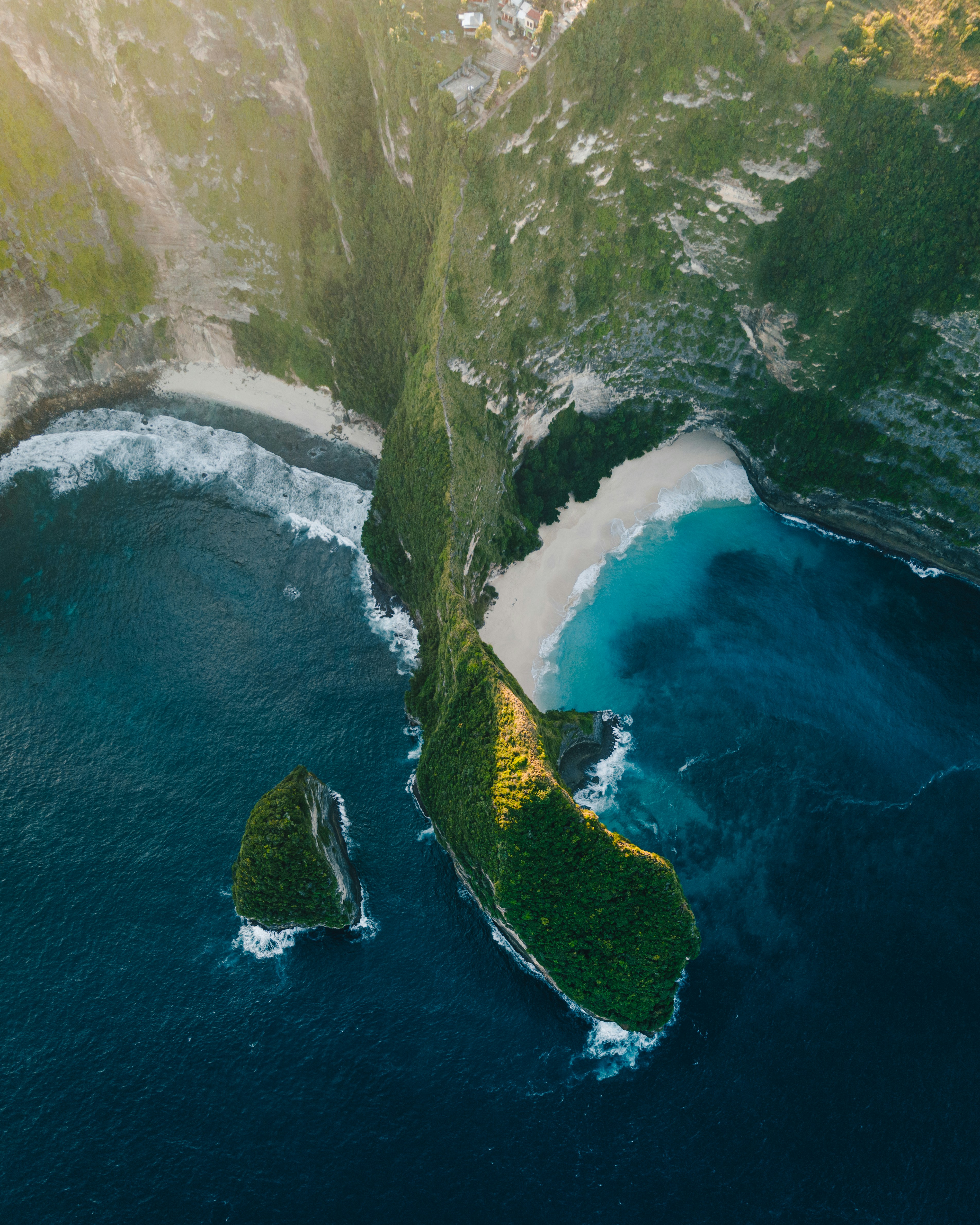 Verdant Spine Splits the Turquoise Sea: A Drone View of a Cliffside Cove