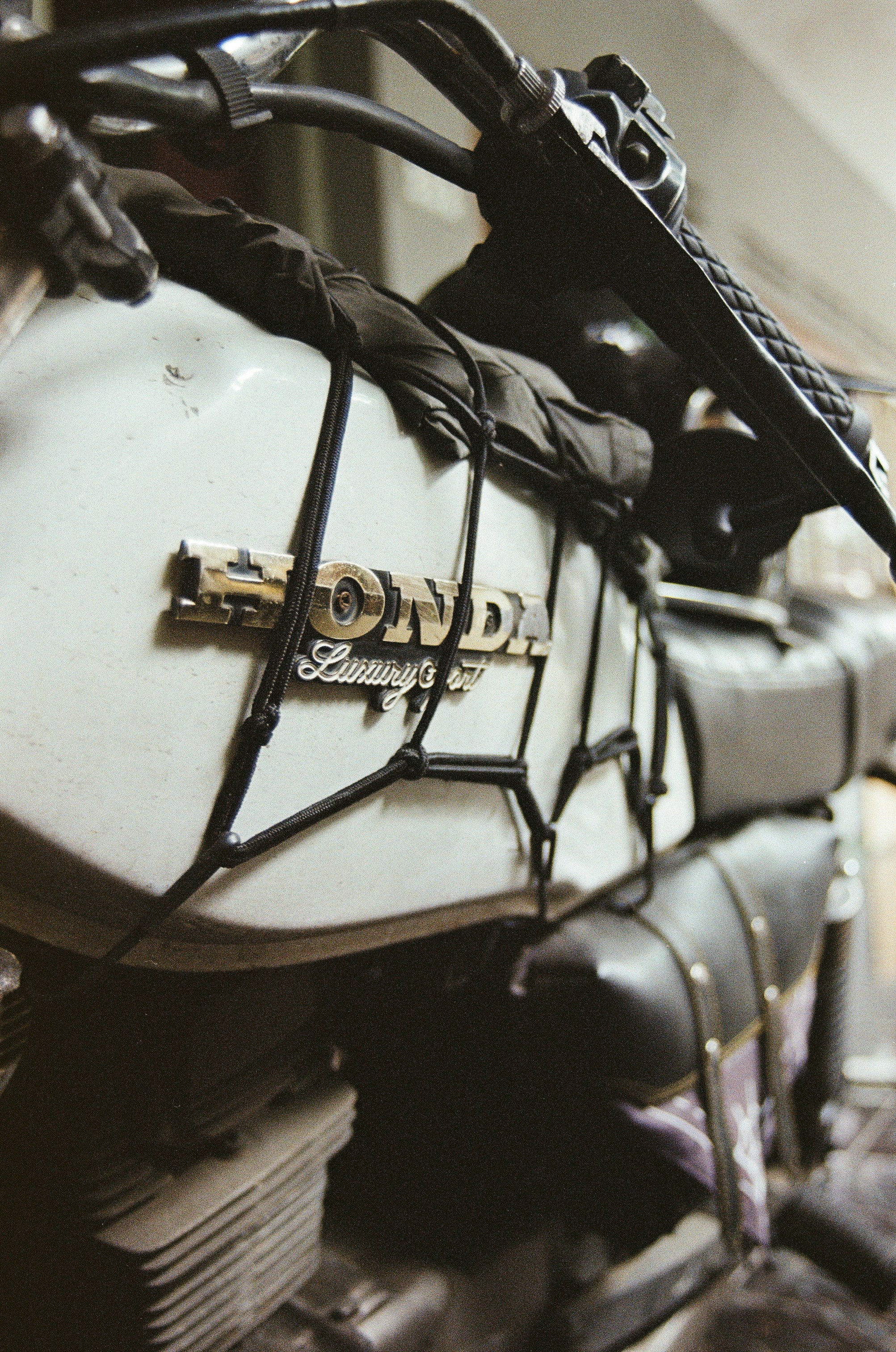 Close-up of a Honda Lumming 750 tank with protective netting in a workshop