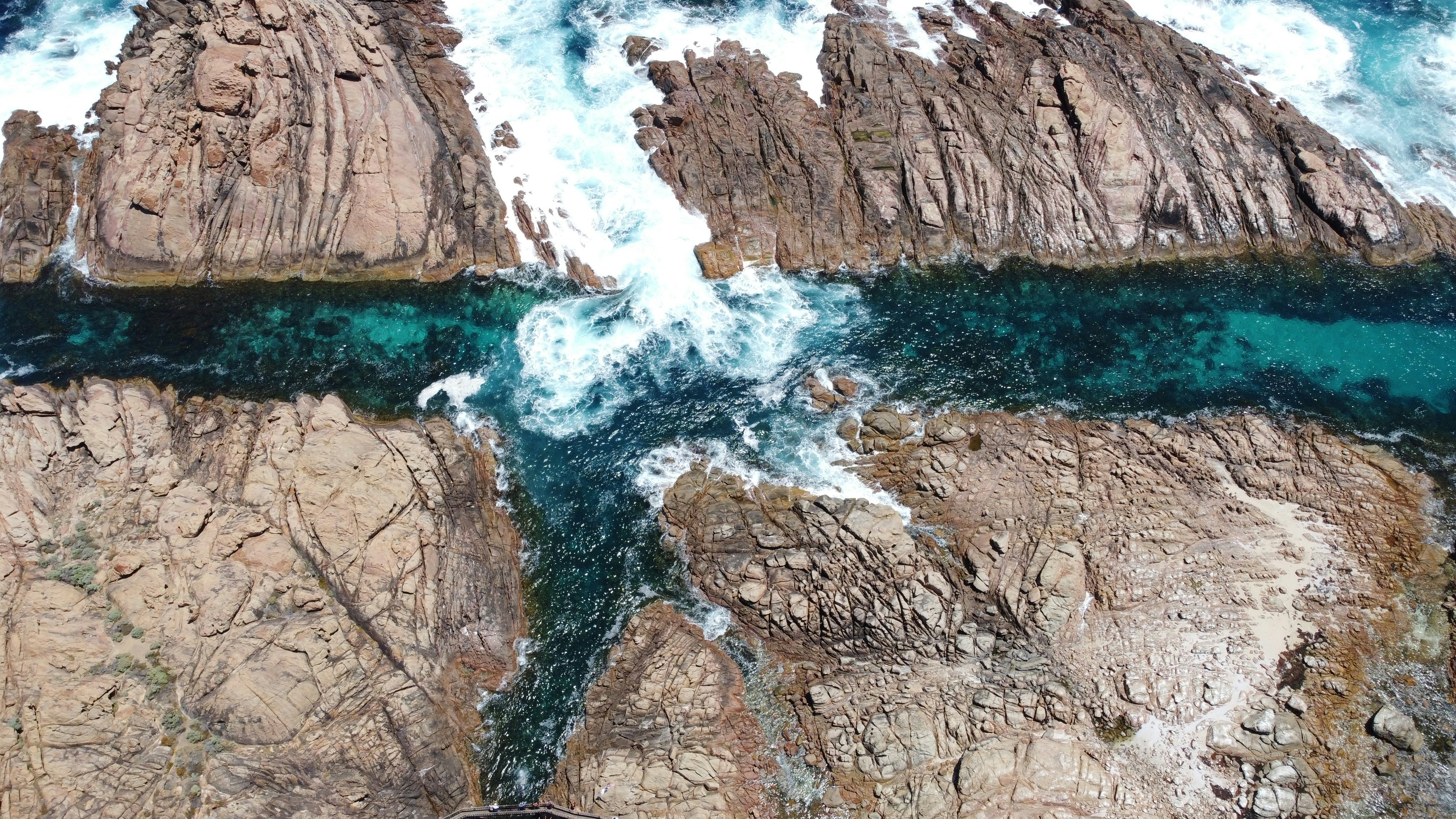 Cerulean Split: Turquoise Channel Woven Between Weathered Cliffs