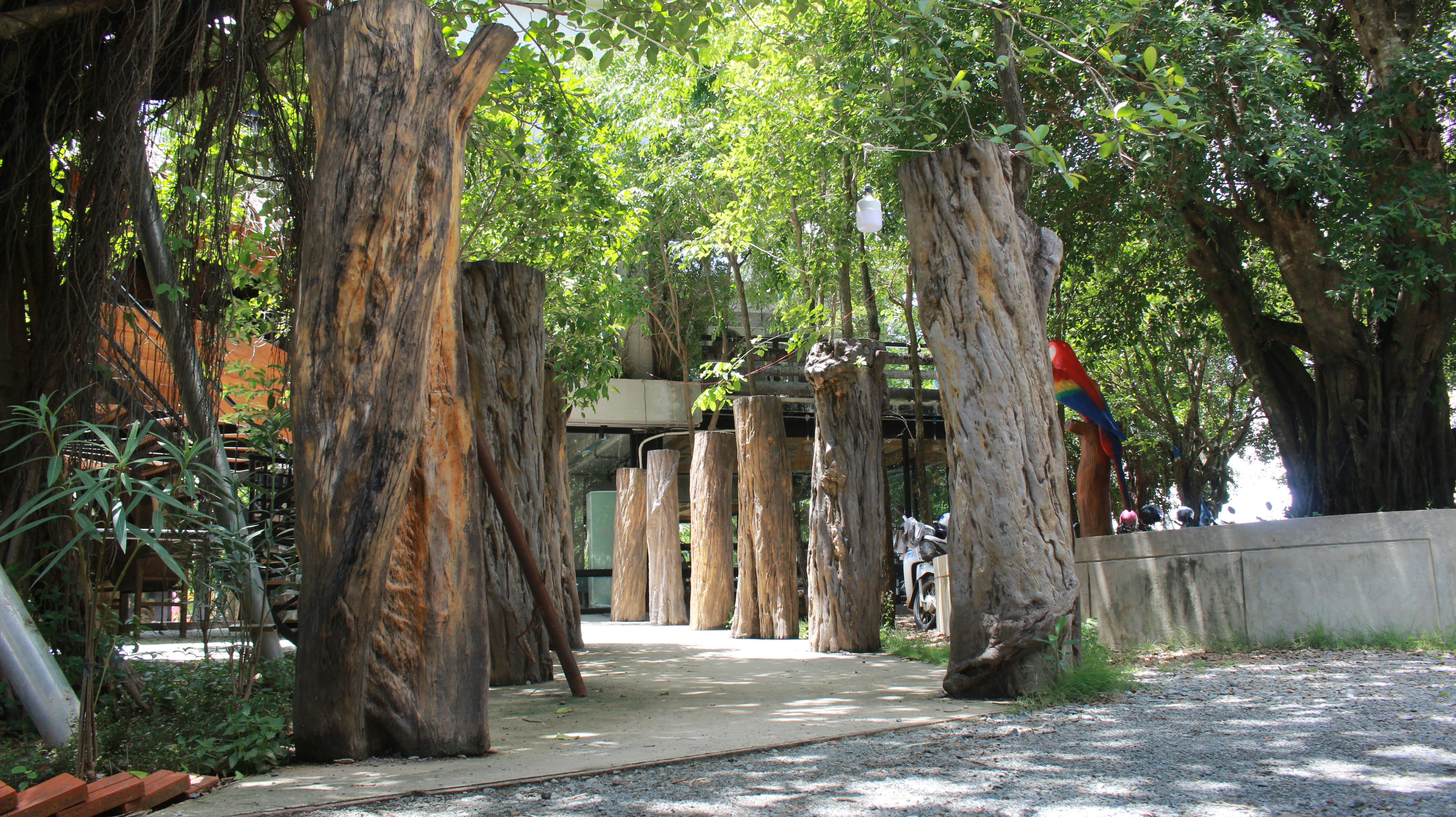 a fence with trees and a building in the background