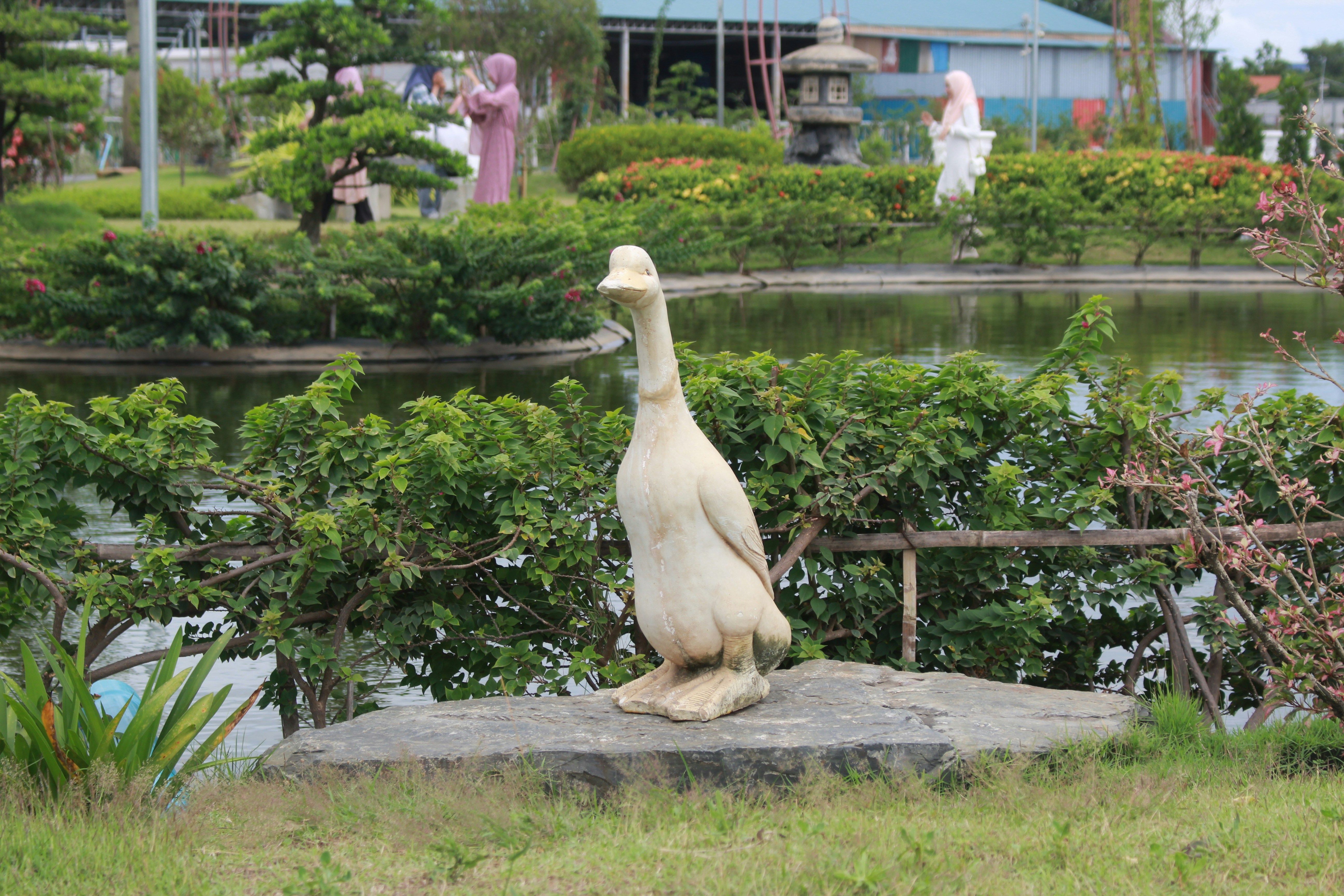 Stone Goose at the Garden Pond: a Quiet Sentinel by the Water