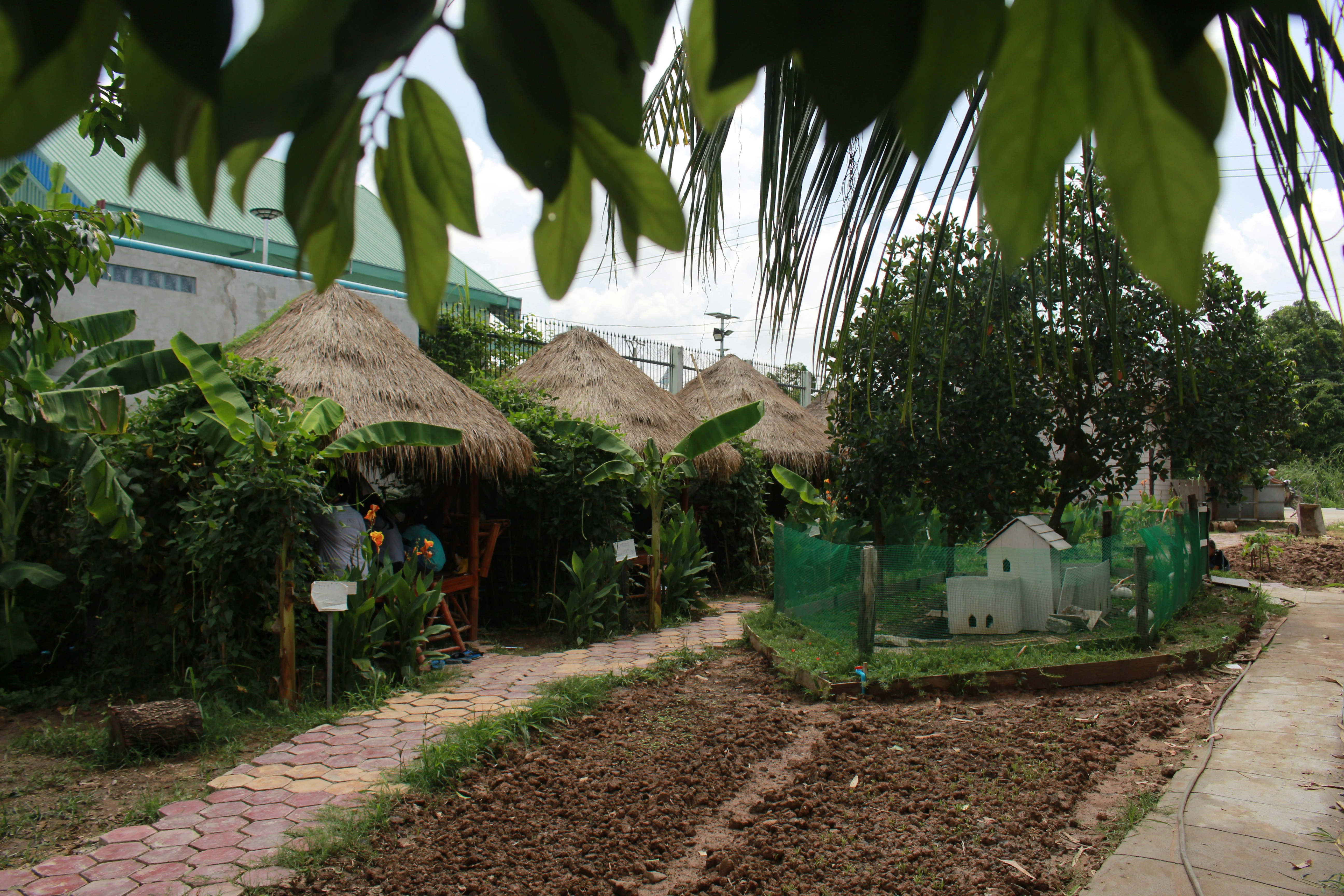 Straw-Hut Village Along a Winding Garden Path