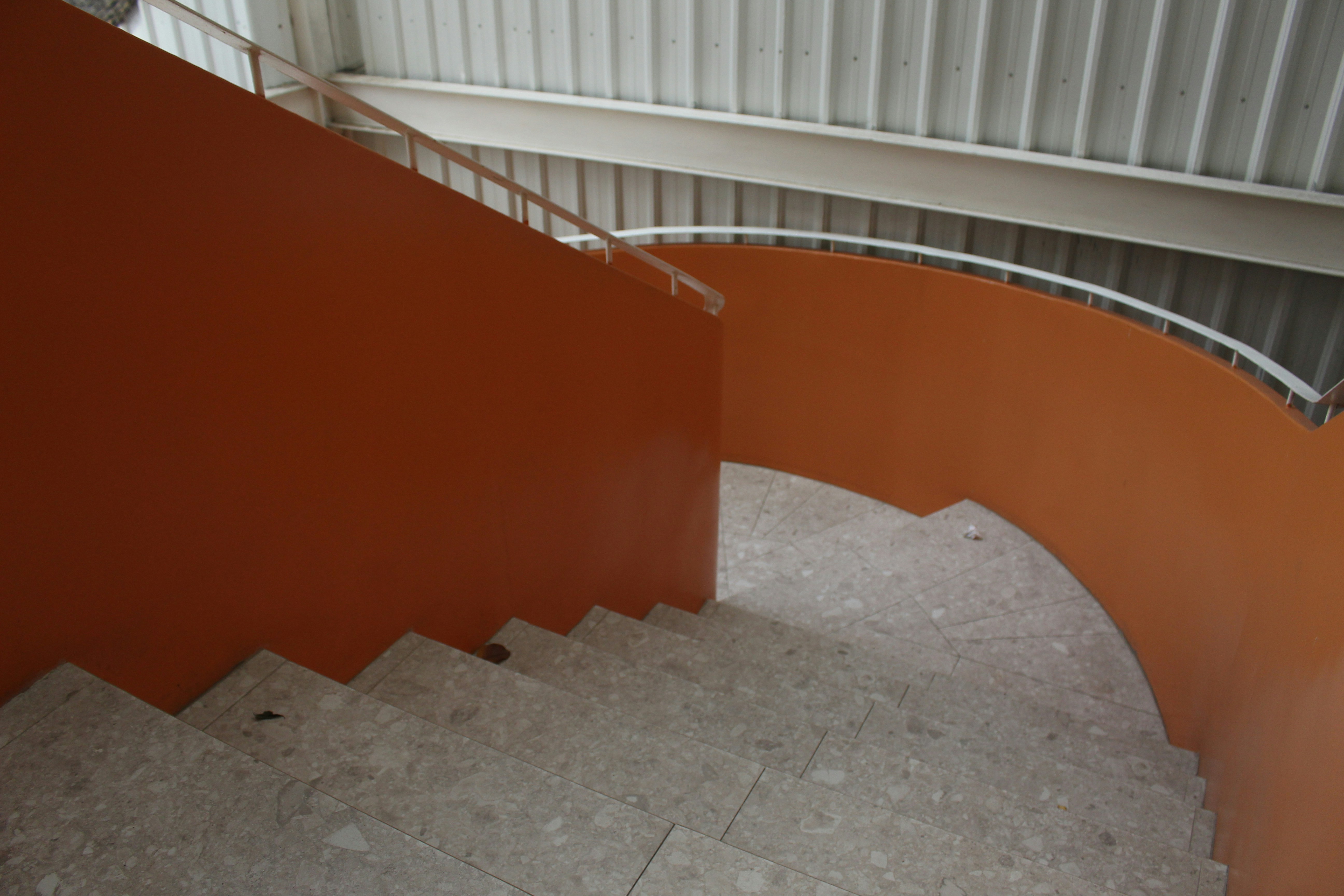 Curve of Descent: An Orange Stairwell's Quiet Geometry
