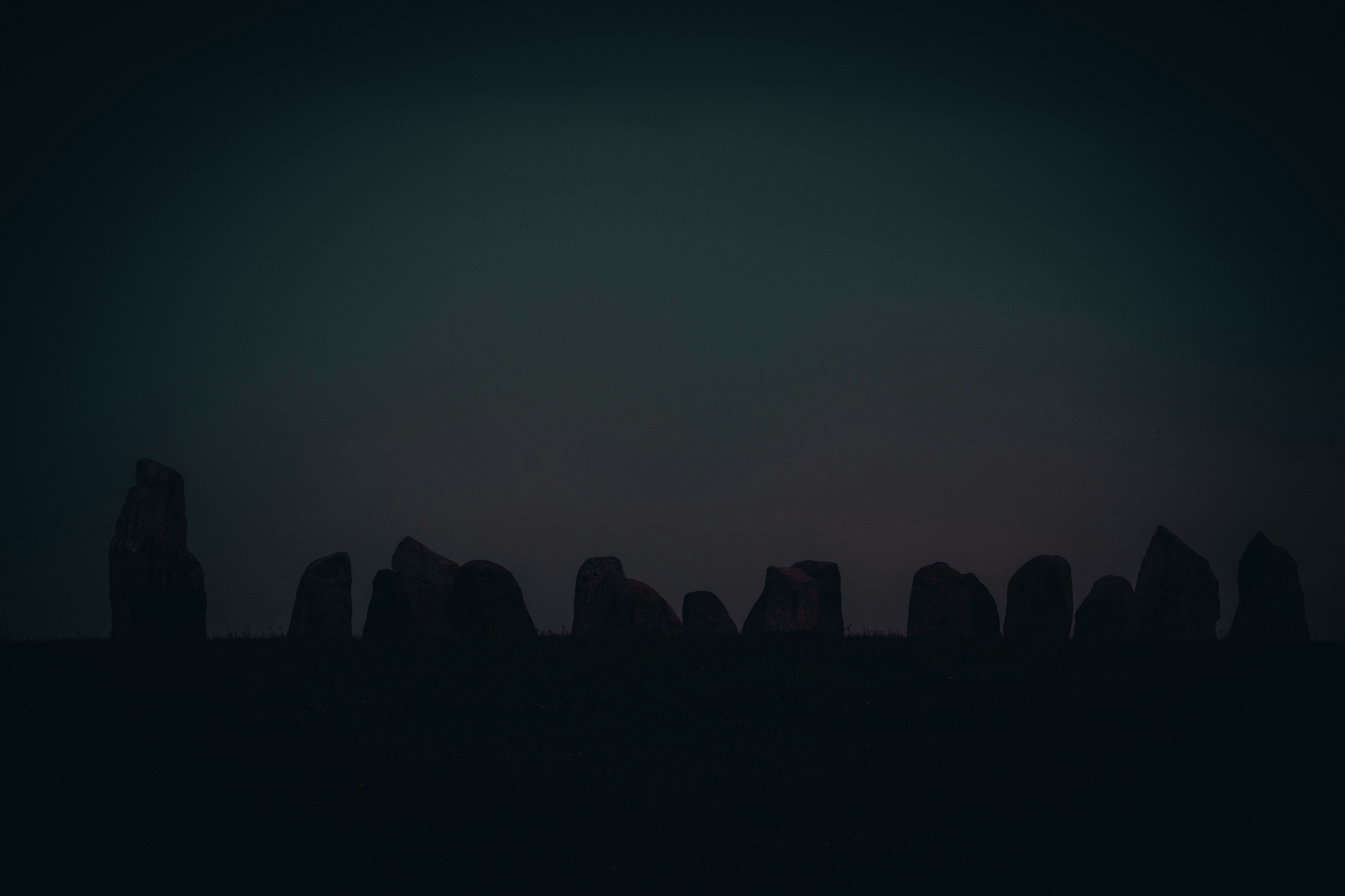 a group of people in a dark cloudy sky