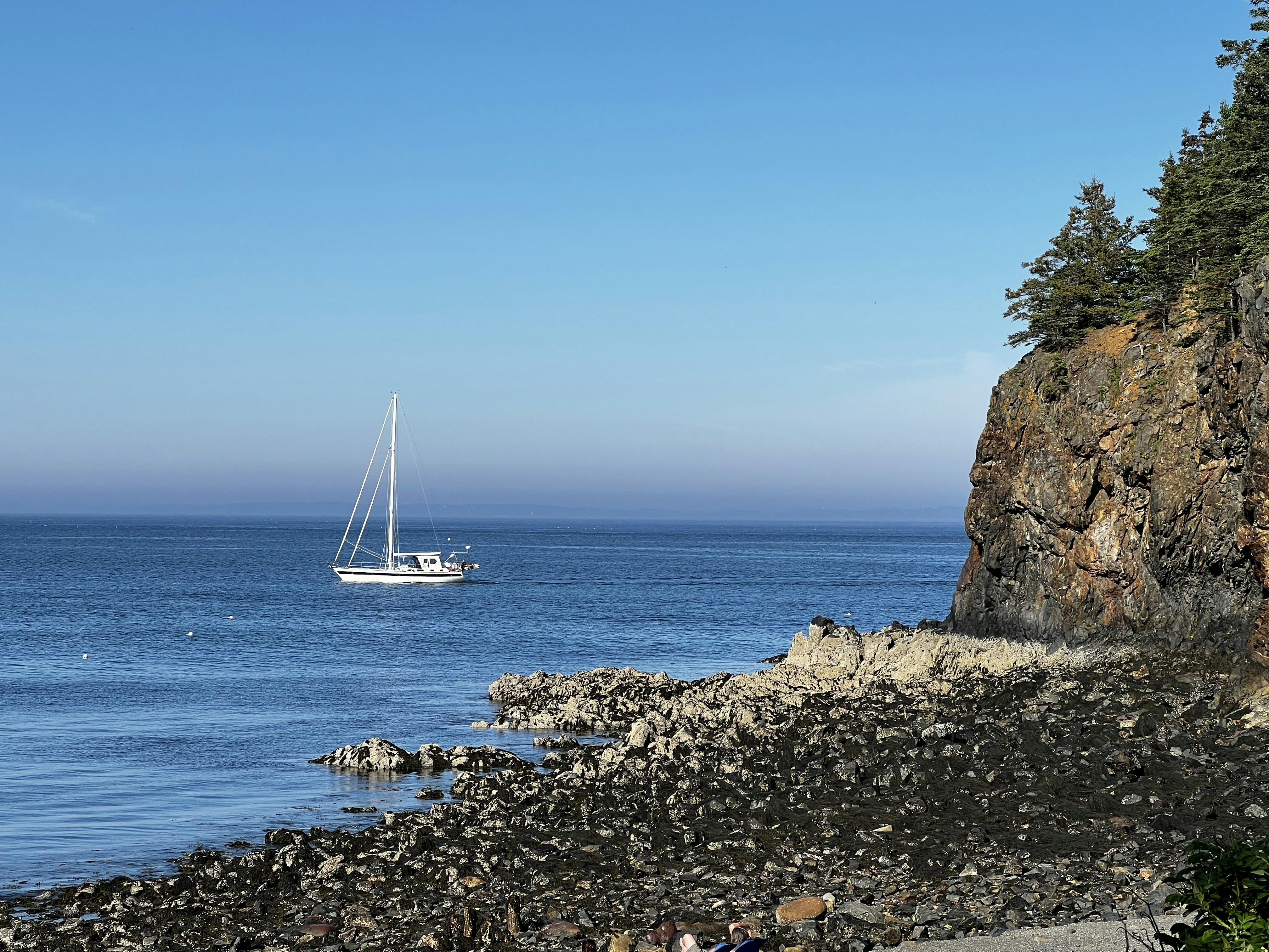 Sailboard rounding the cliffs at Owls Head Lighthouse.