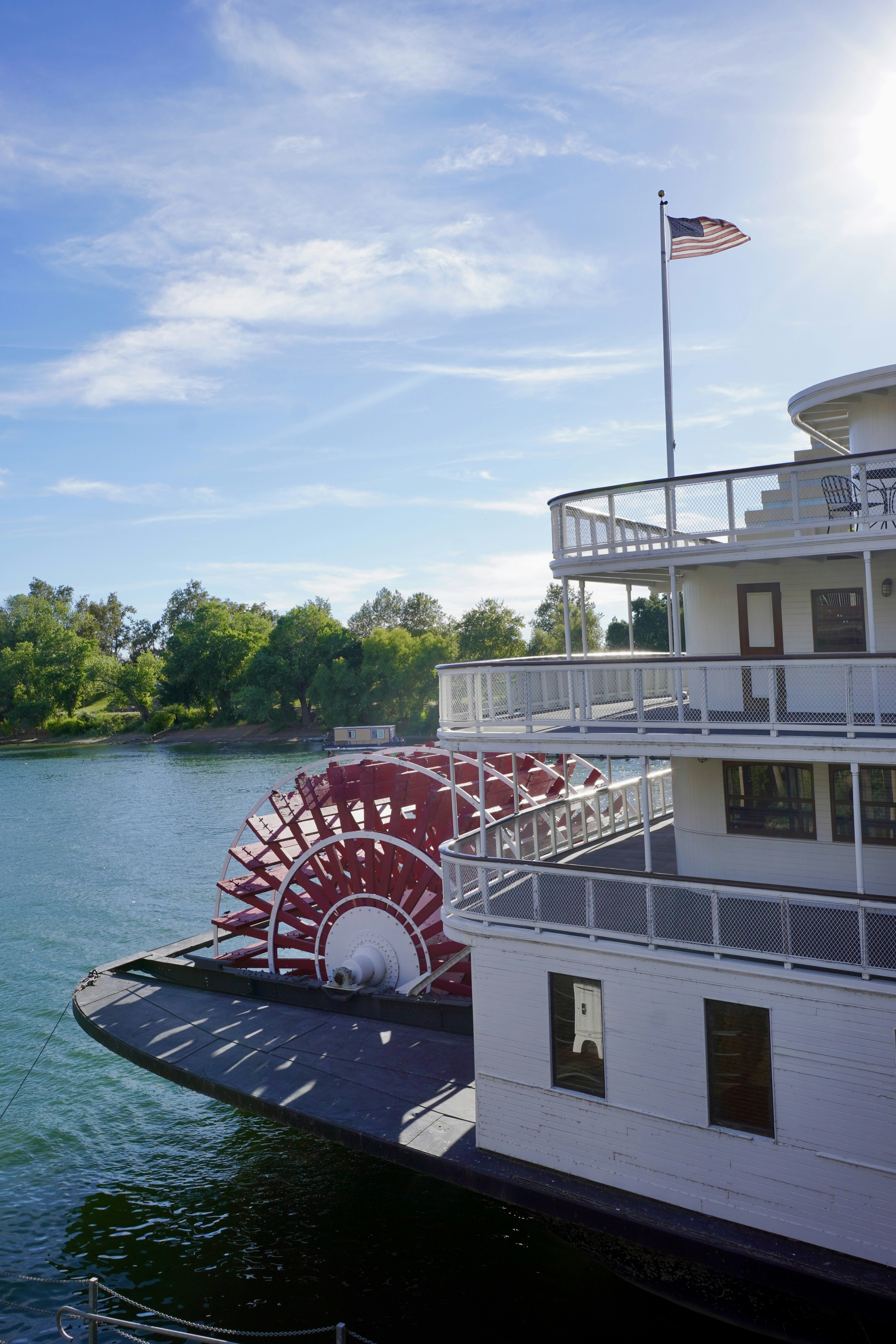 Sunlit Riverboat Spindle and Waterfront Deck