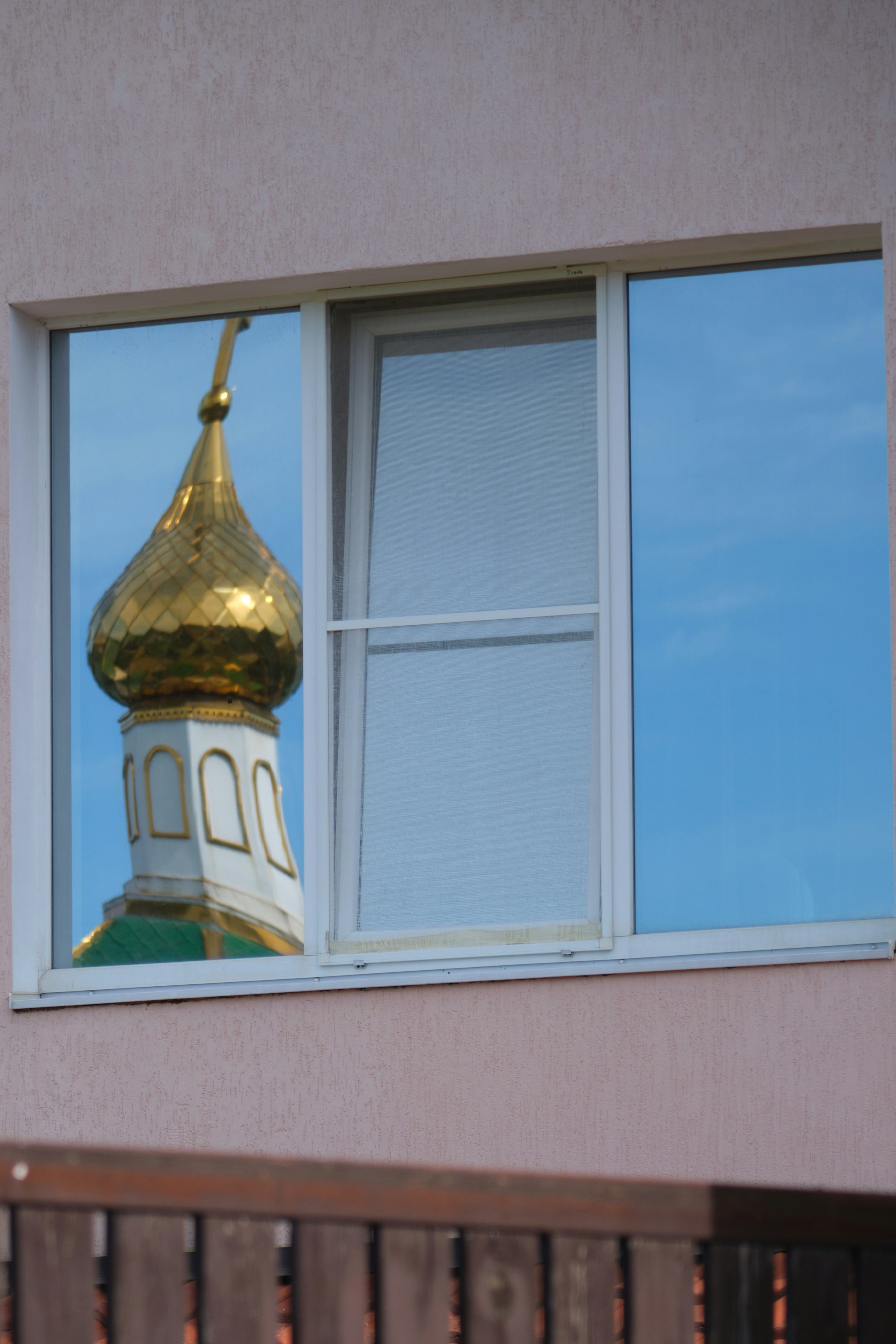 Golden Dome Beside Window: Reflections of a Quiet Courtyard