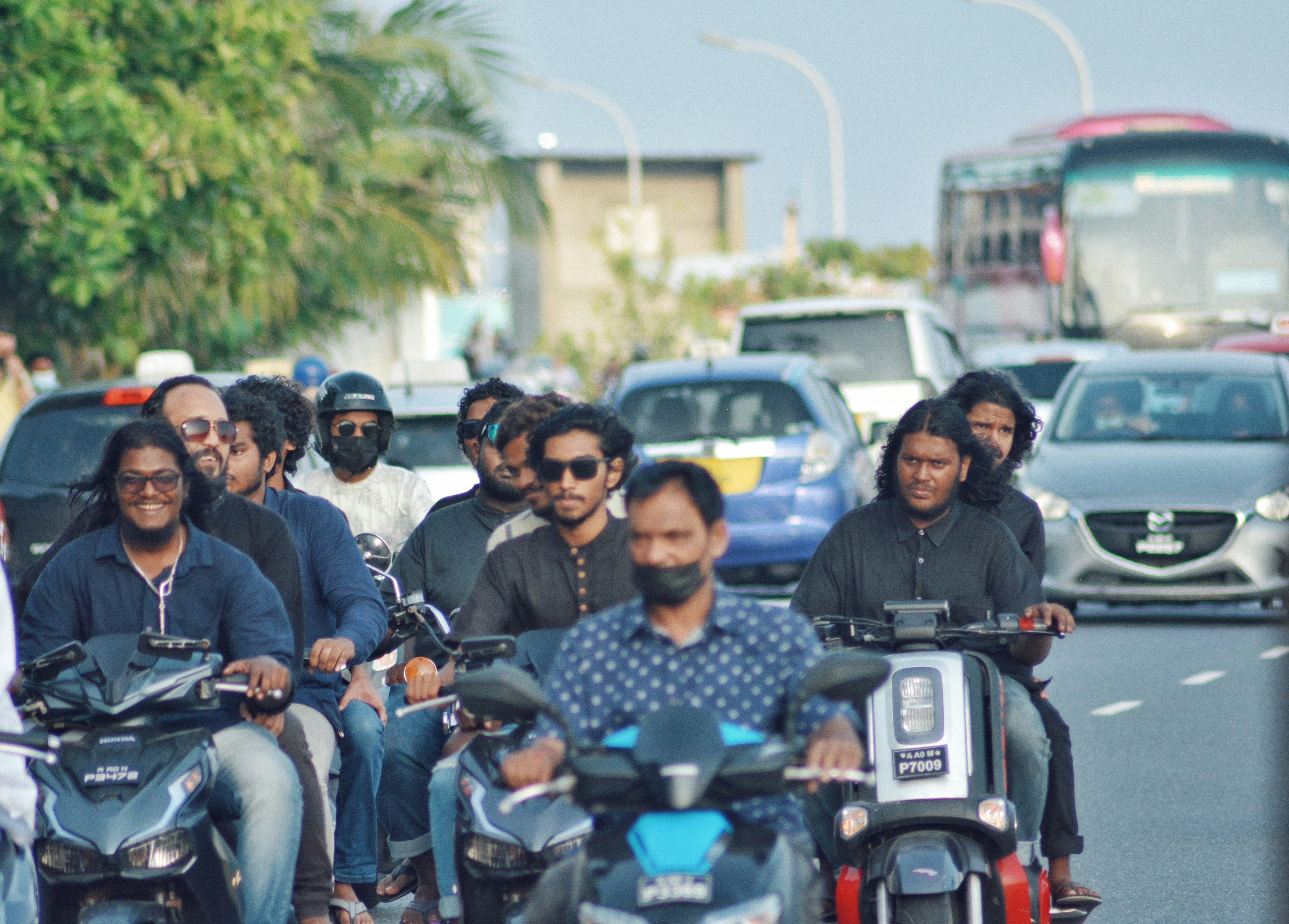 Converging Wheels: A Dense Line of Riders Across a City Boulevard
