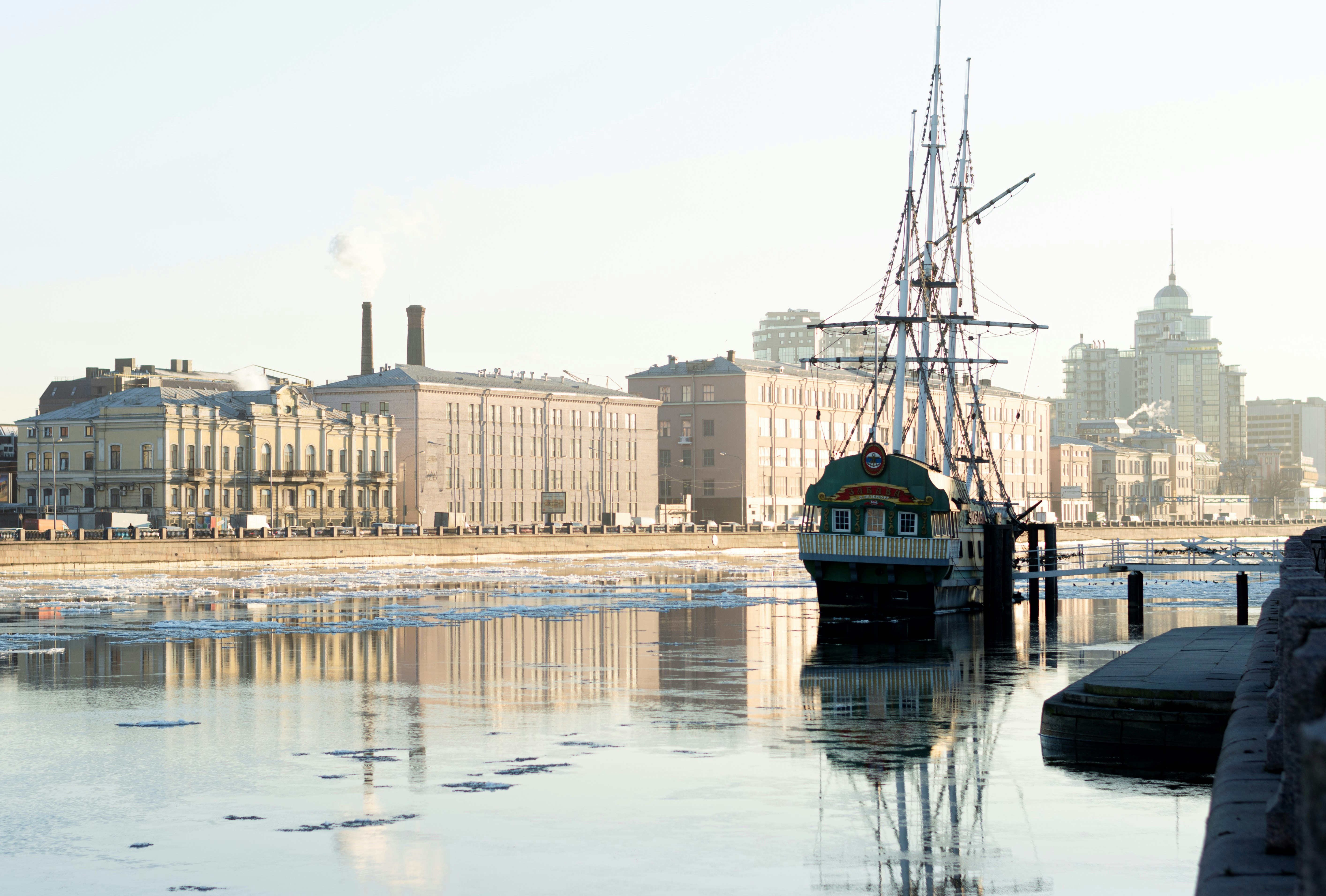 Harbor Wake: A Sailor’s Vessel Docked Along a Quiet Riverfront