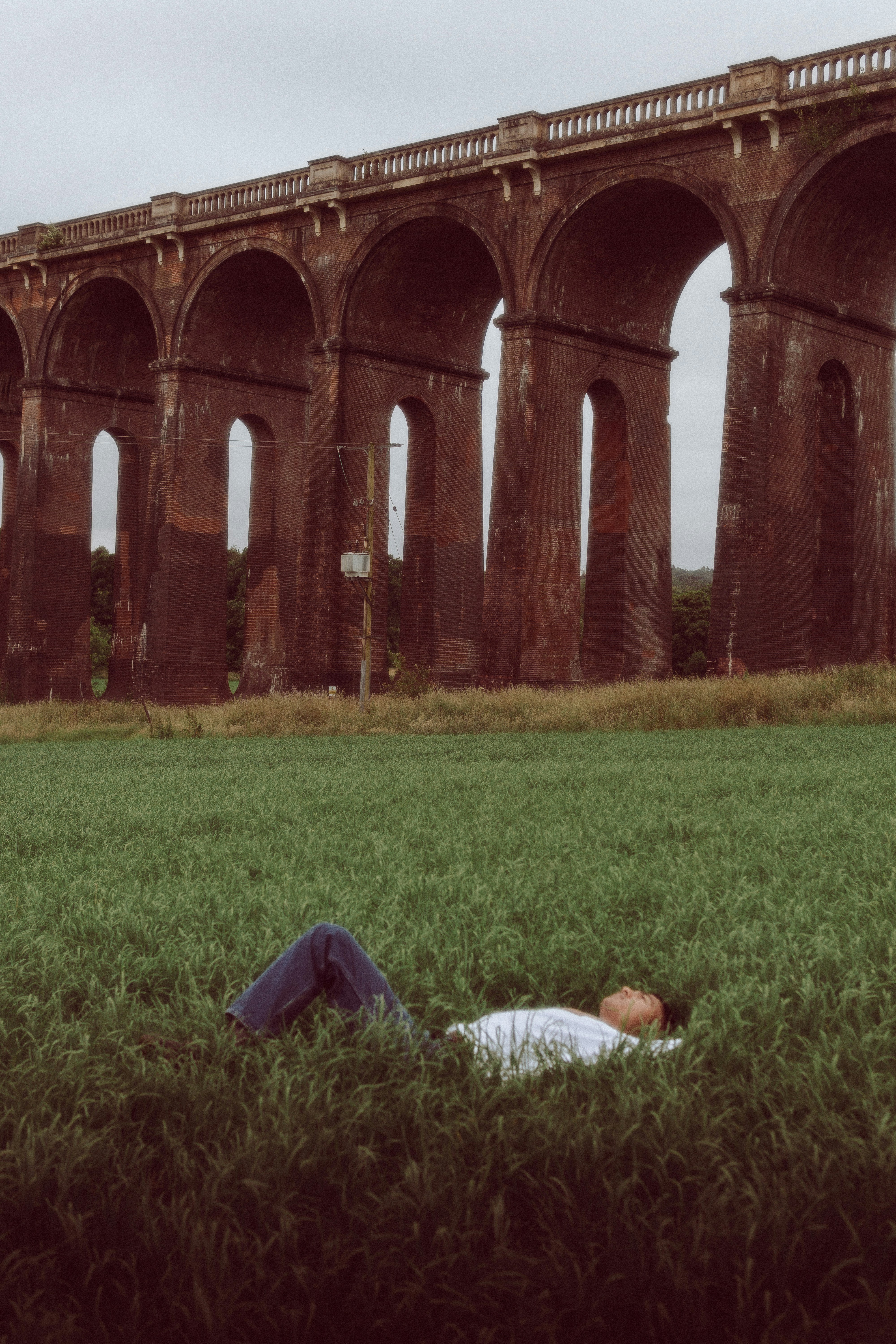 Resting Beneath Giants: a Quiet Moment Under the Brick Viaduct