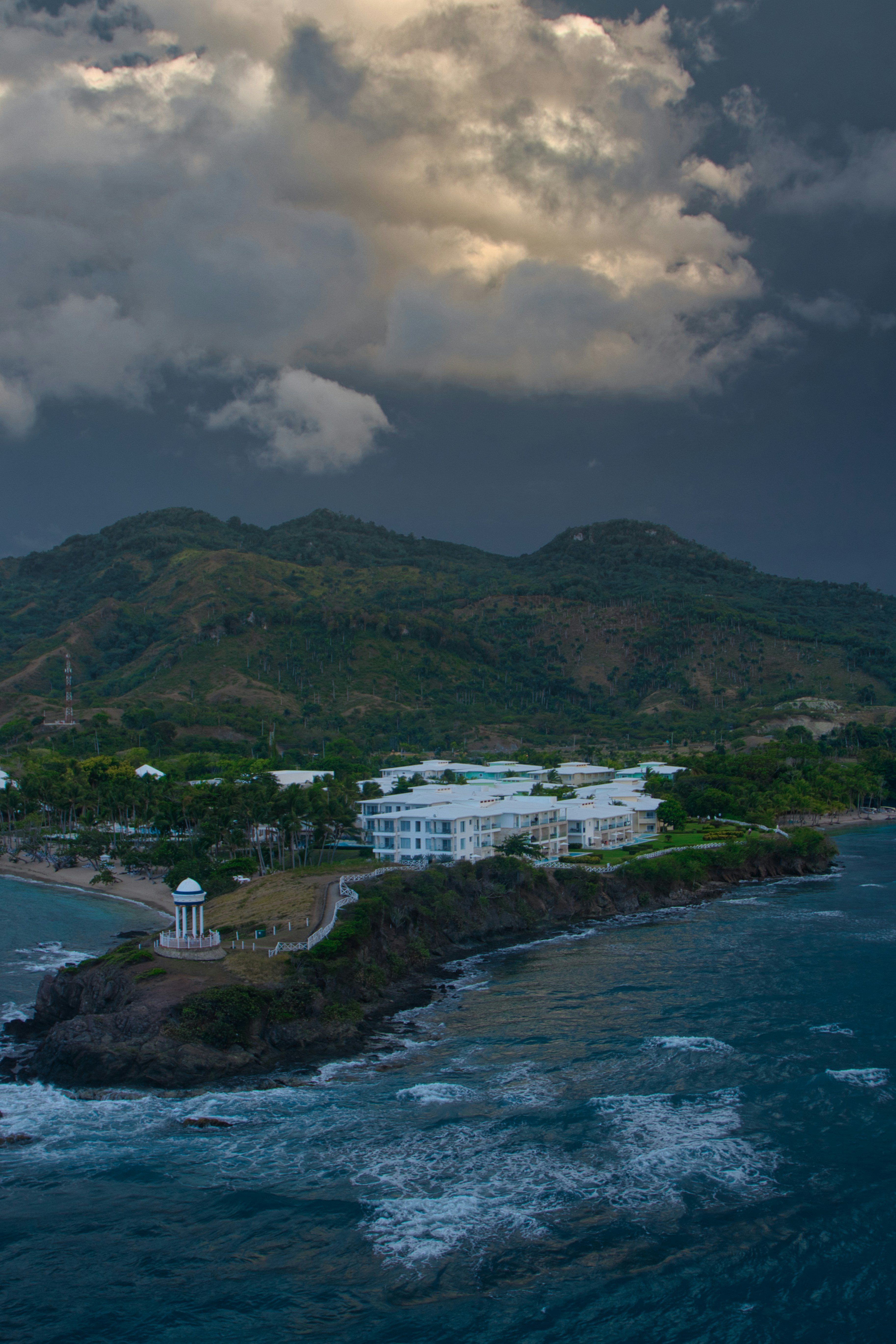 a building on a hill by the water