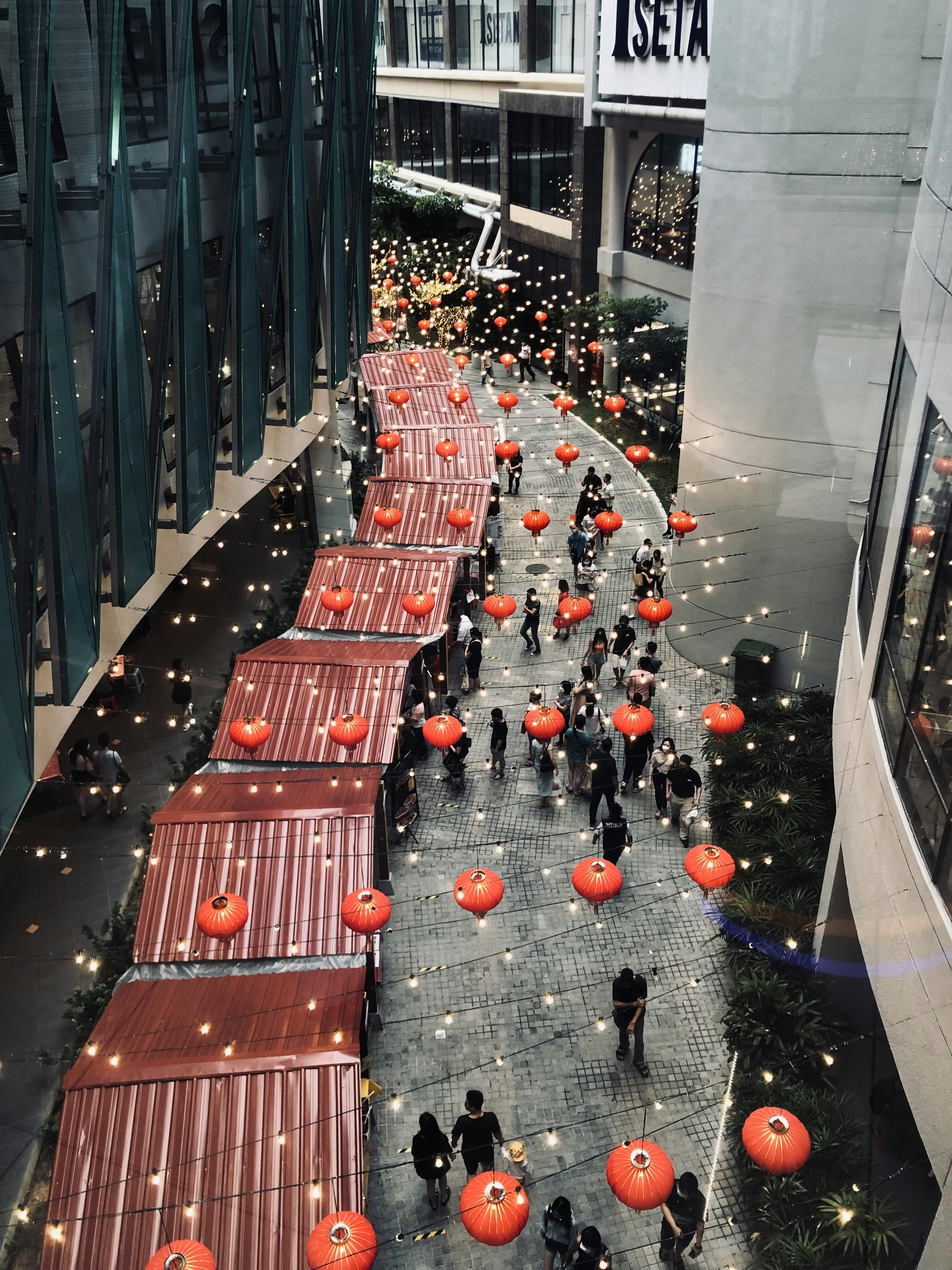 Lanterns over the Mall: Red Orbs Drift Through a Modern Atrium