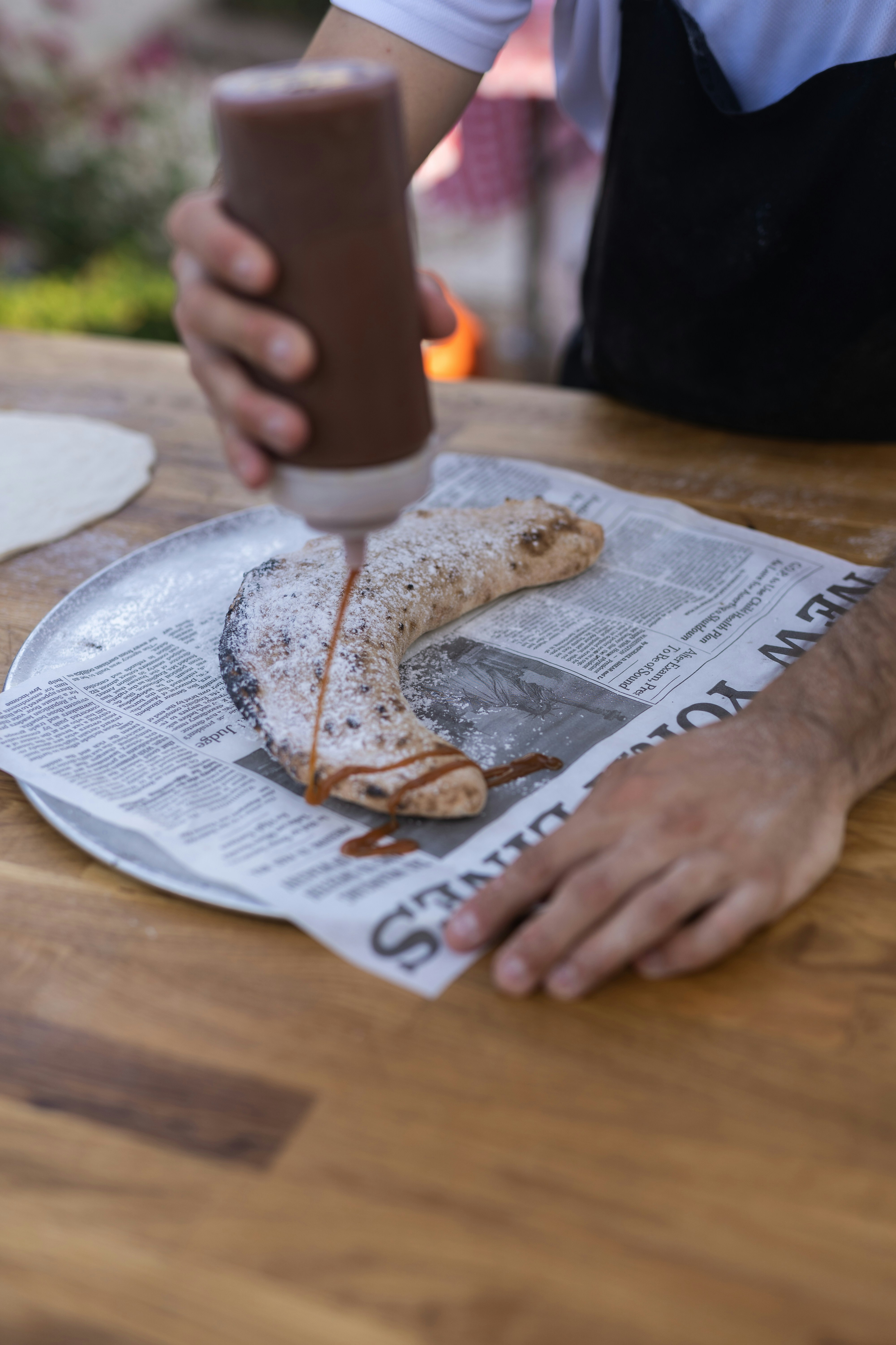 Crescent on Newspaper: Velvet Chocolate Drizzle Finishes a Café Pastry