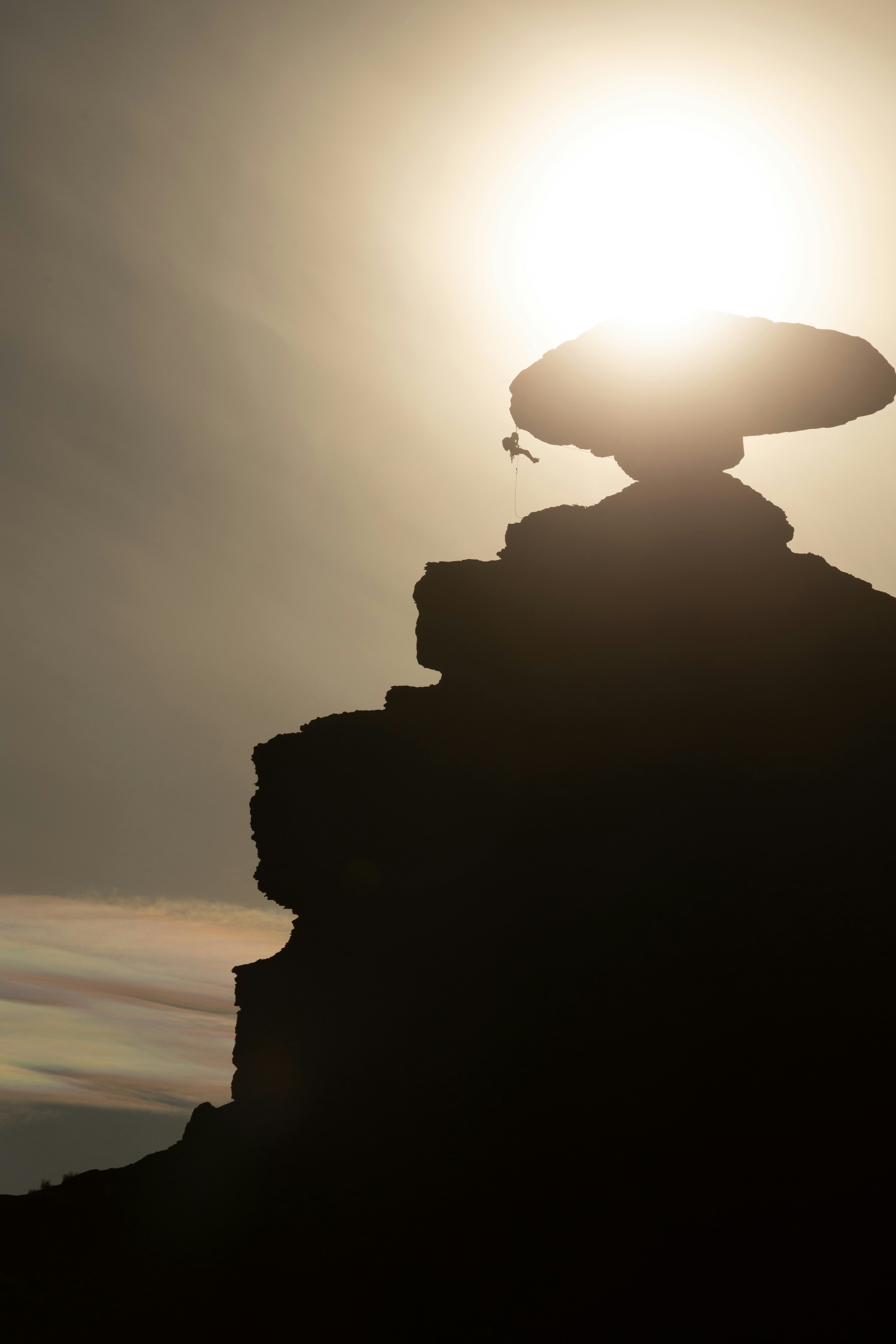A large rock formation with a bright light shining on it photo – Free ...