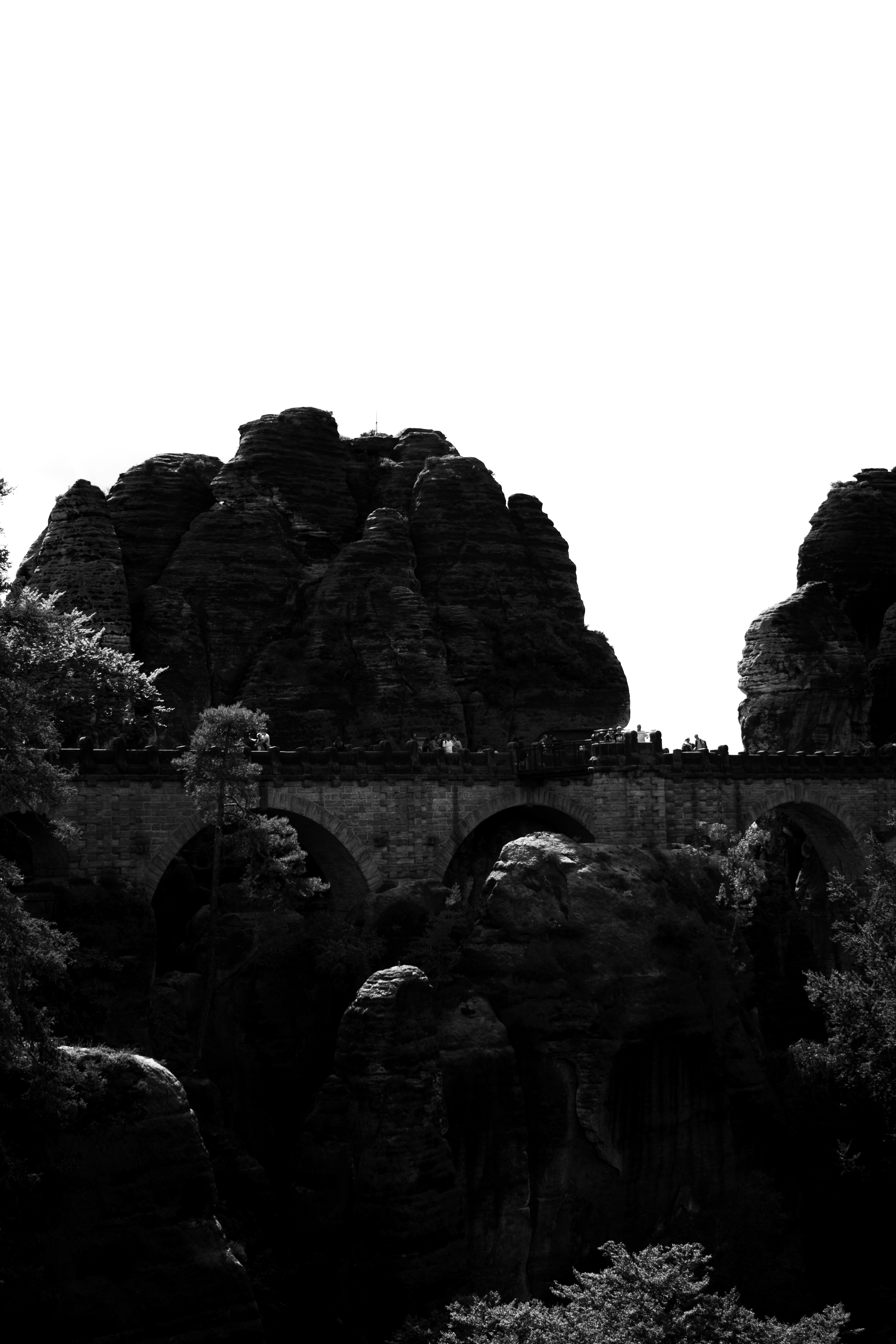Silhouette of a Stone Viaduct Amid Towering Rock Giants