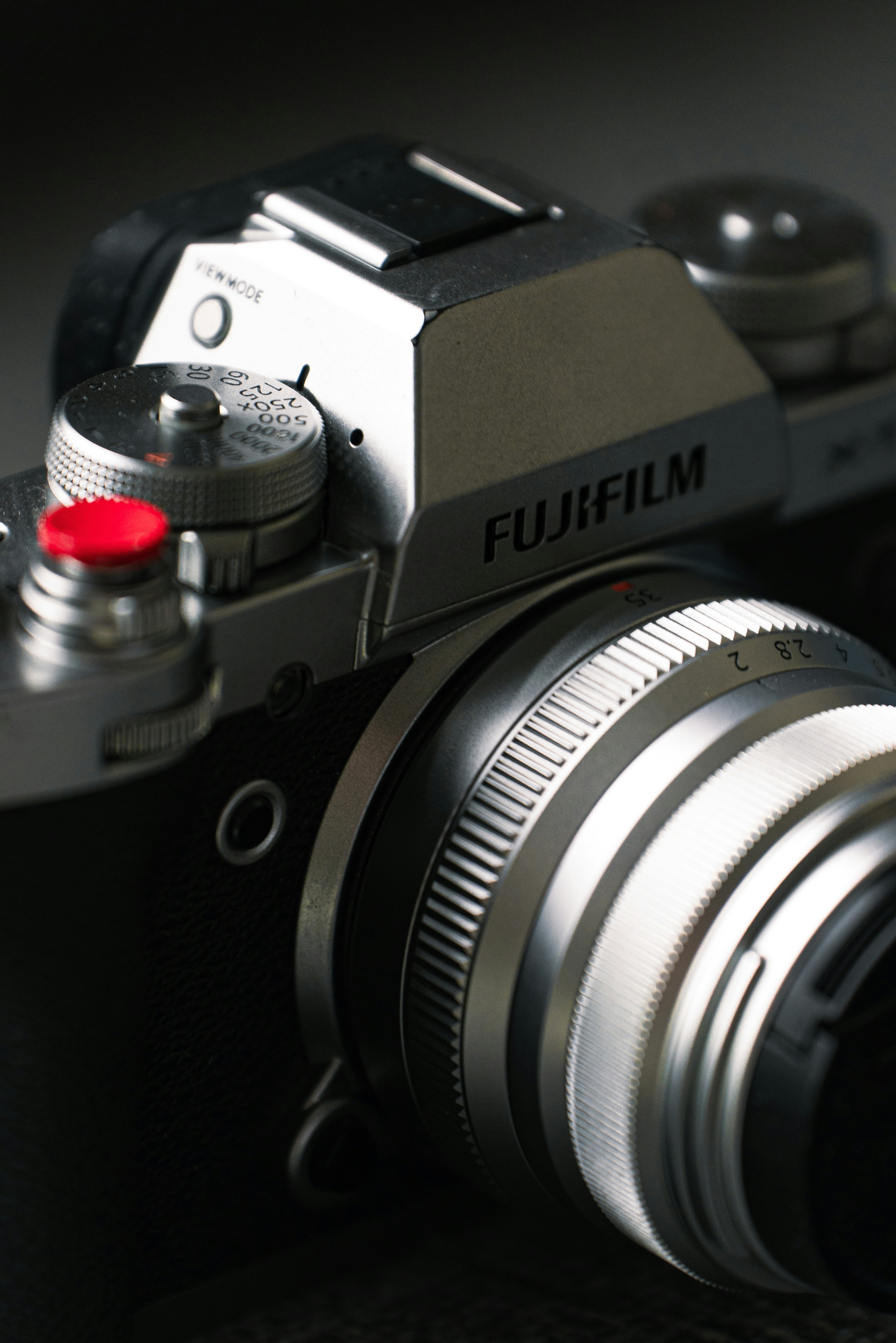 Close-up of a Fujifilm camera showcasing its intricate controls and sleek metallic finish.