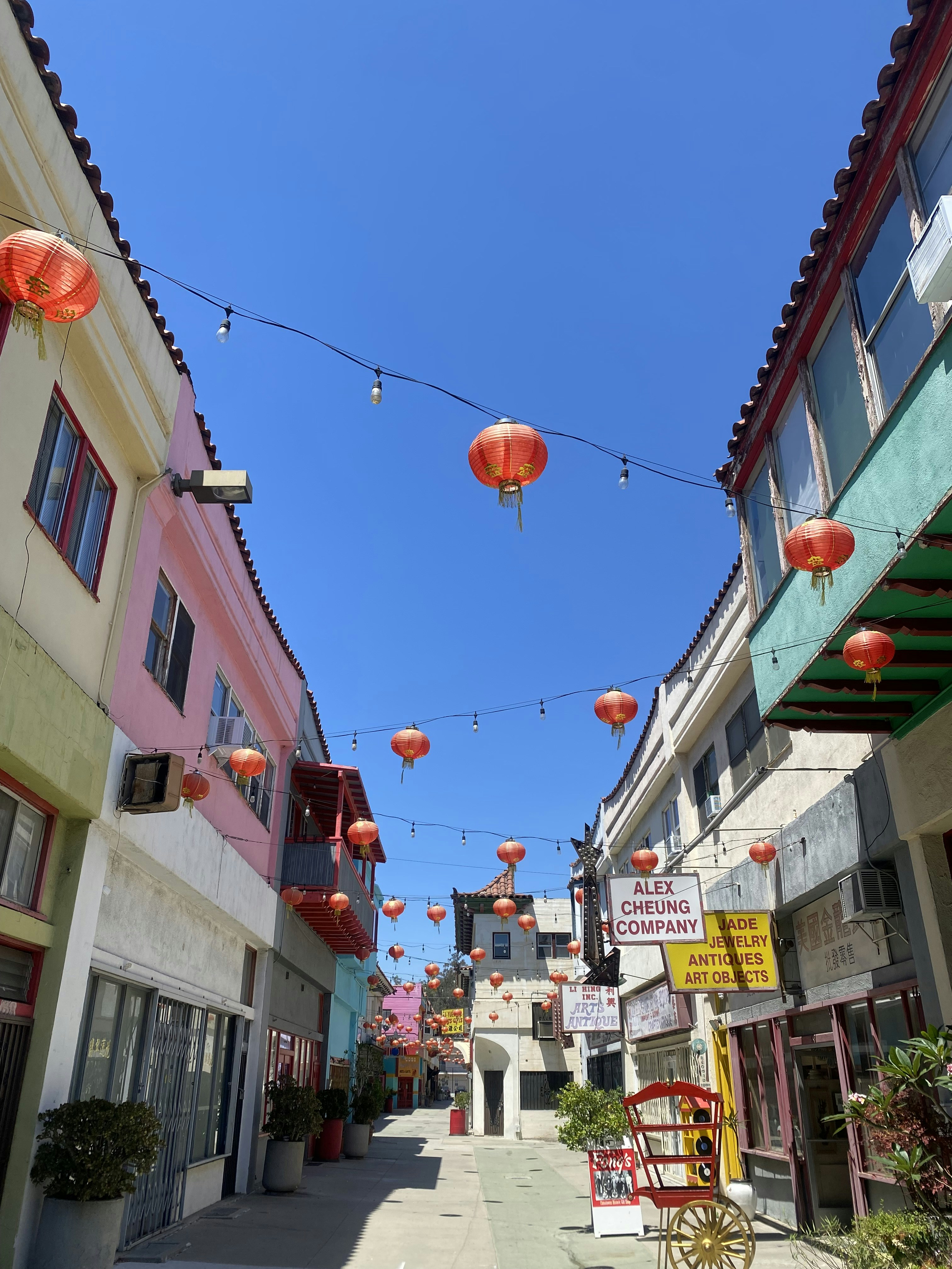 Lantern-Lined Alley: Sunlit Pastel Facades in a Chinatown-Inspired Street