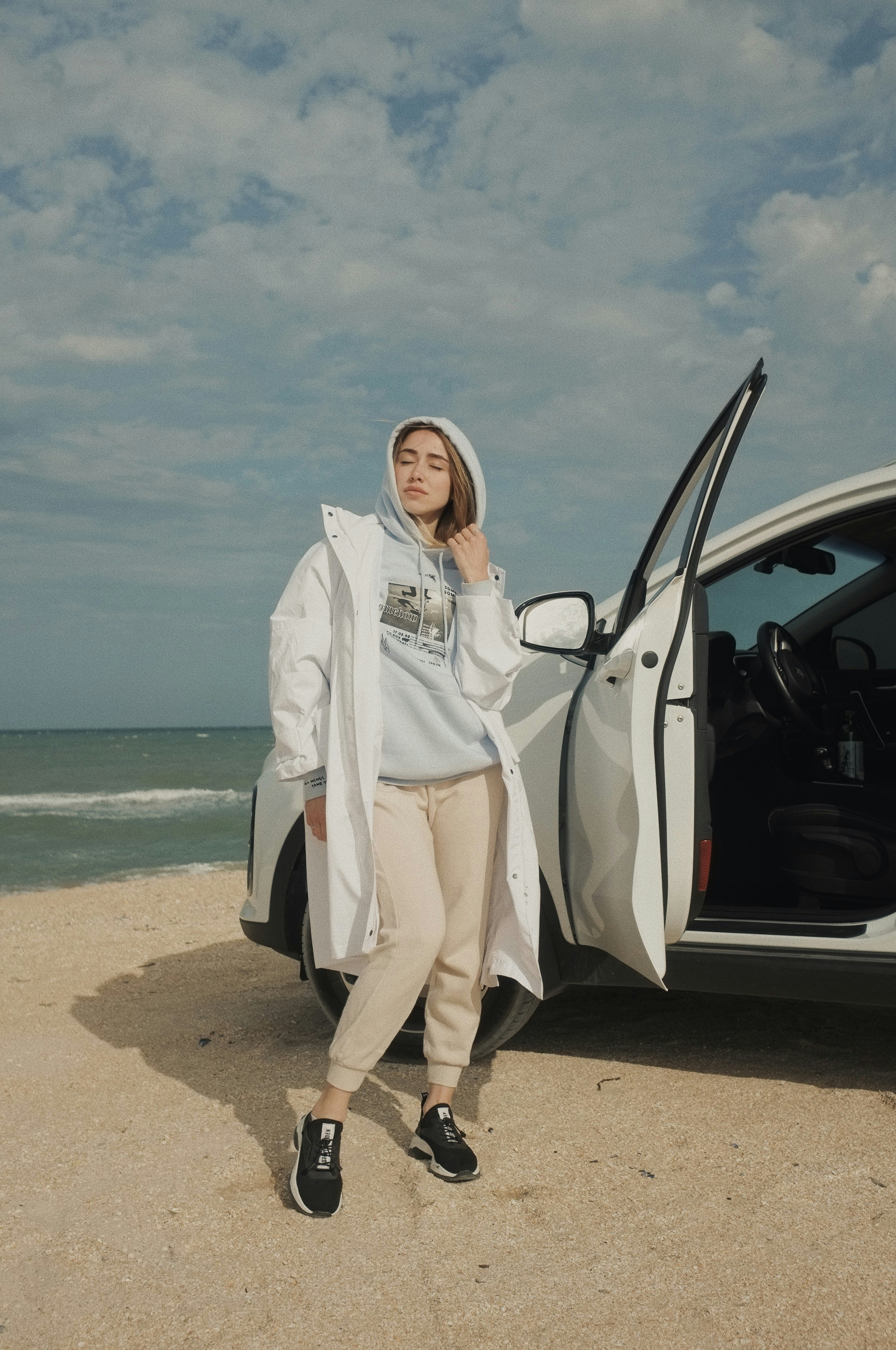 Salt-Tide Portrait: A Calm Beach Moment by an Open Car Door