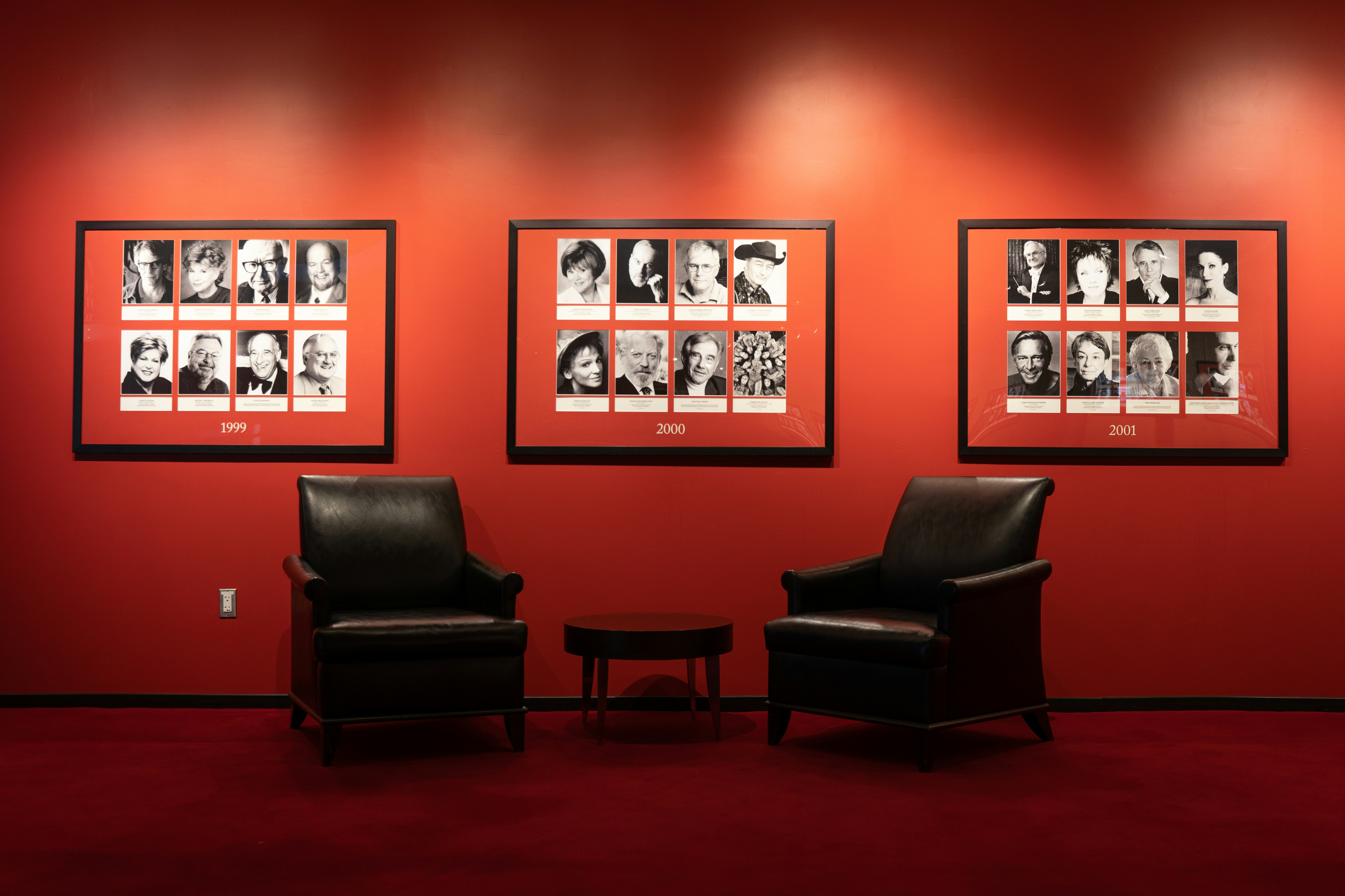 Crimson Gallery Centerpiece: Portrait Collages Flanked by Velvet Seating