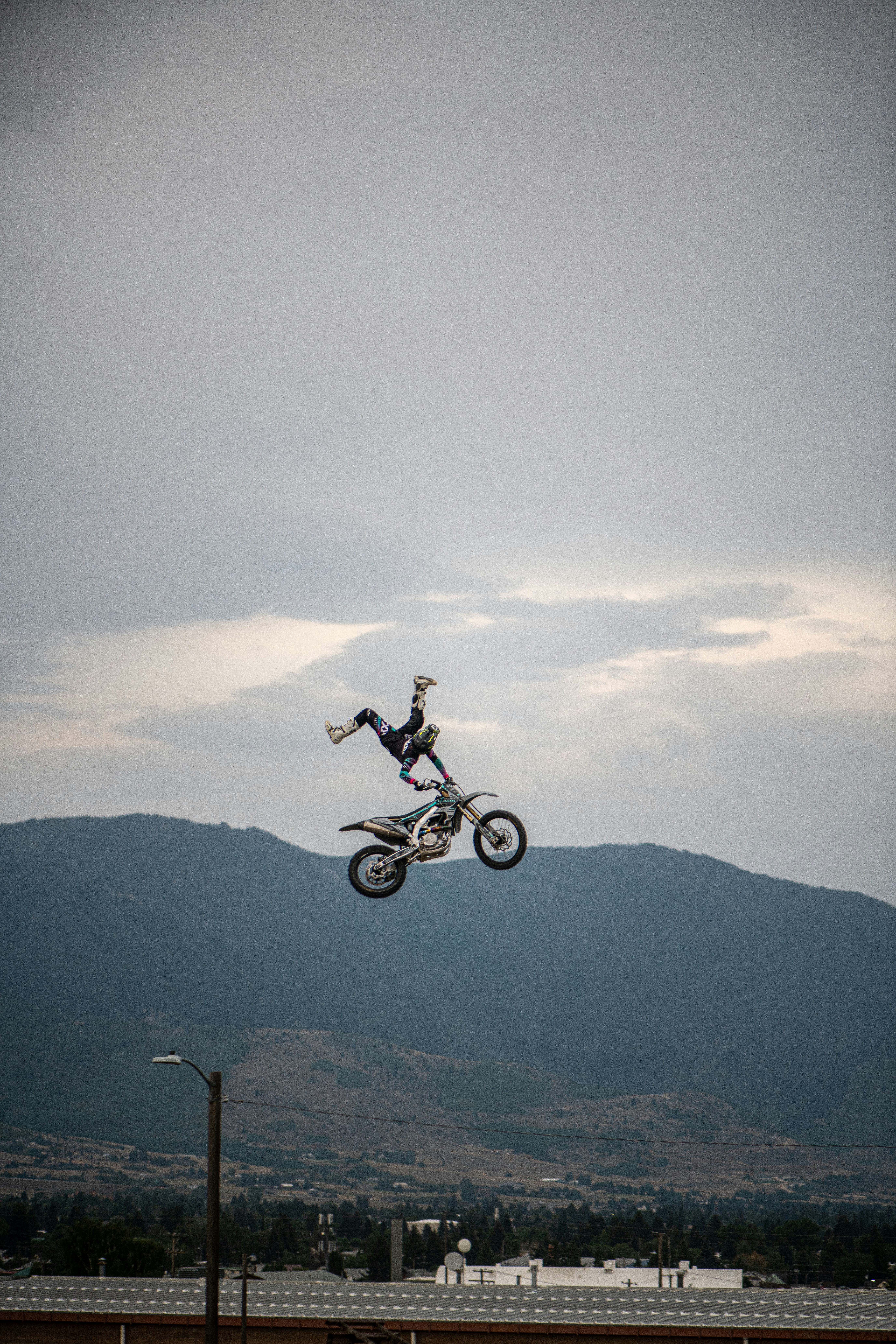 A person doing a trick on a motorcycle photo – Free Grey Image on Unsplash
