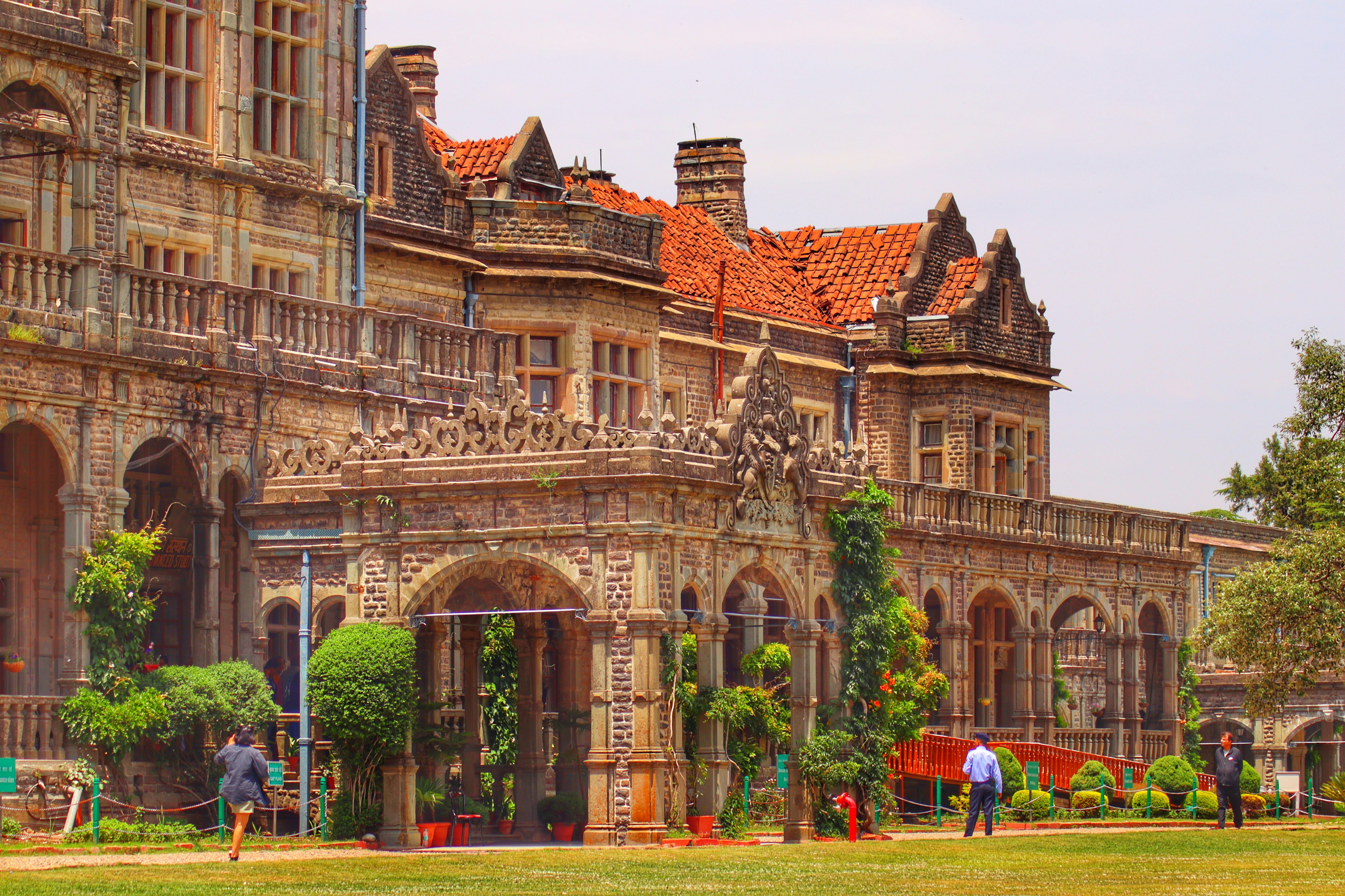 Ornate Historic Campus Gate Under Warm Bright Sky