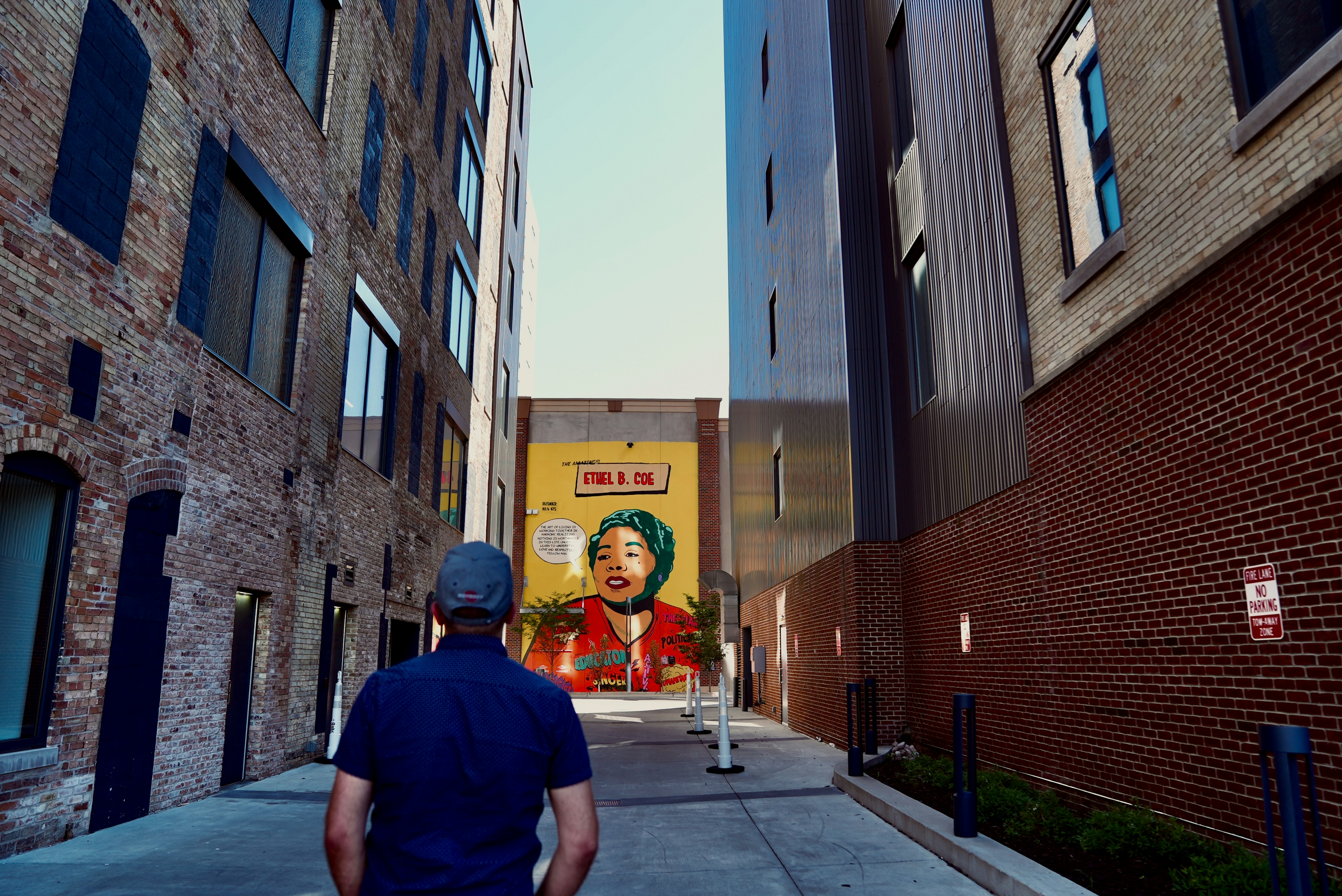 a man walking on a sidewalk