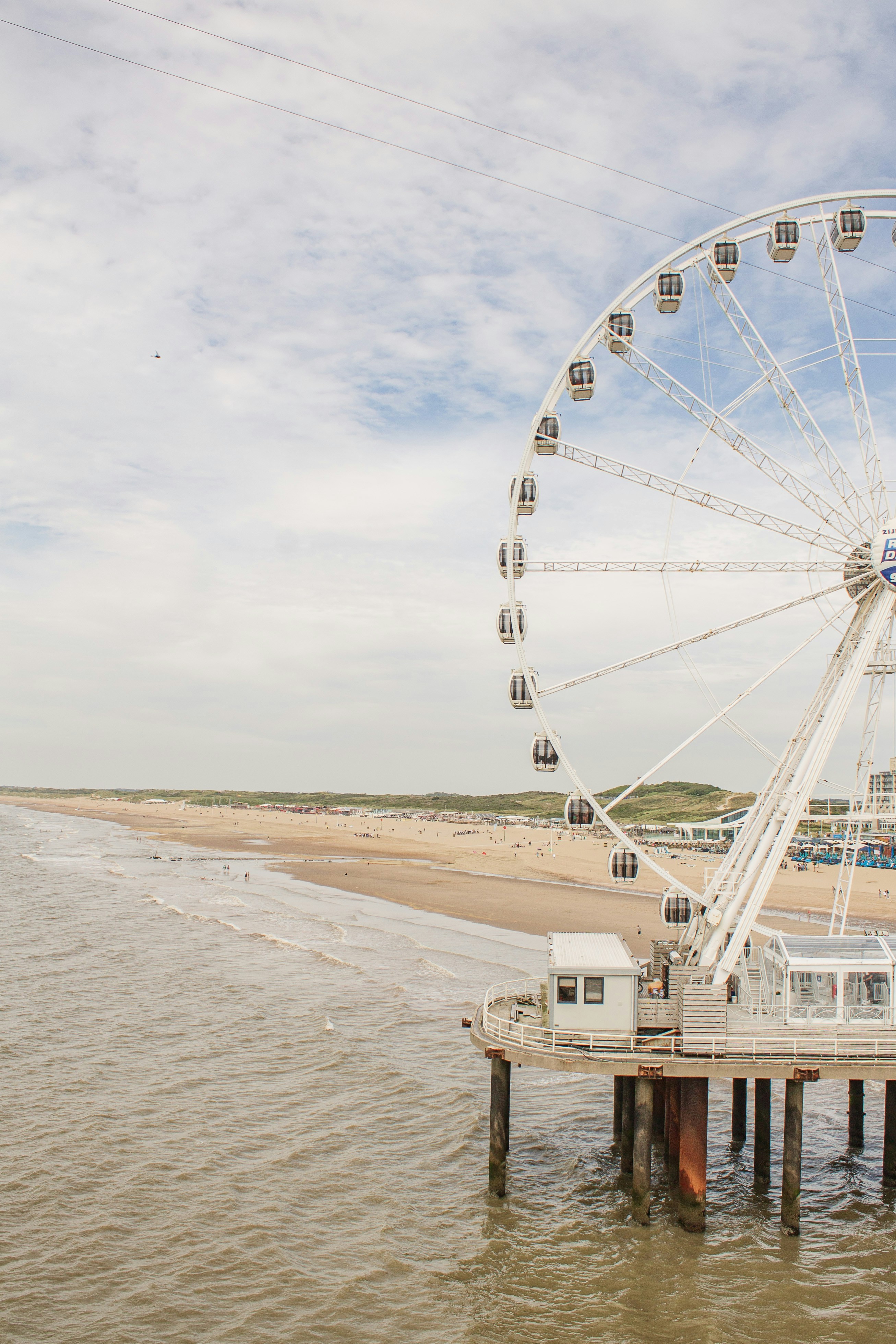 Giant Wheel Overlooking a Calm Coastal Pier