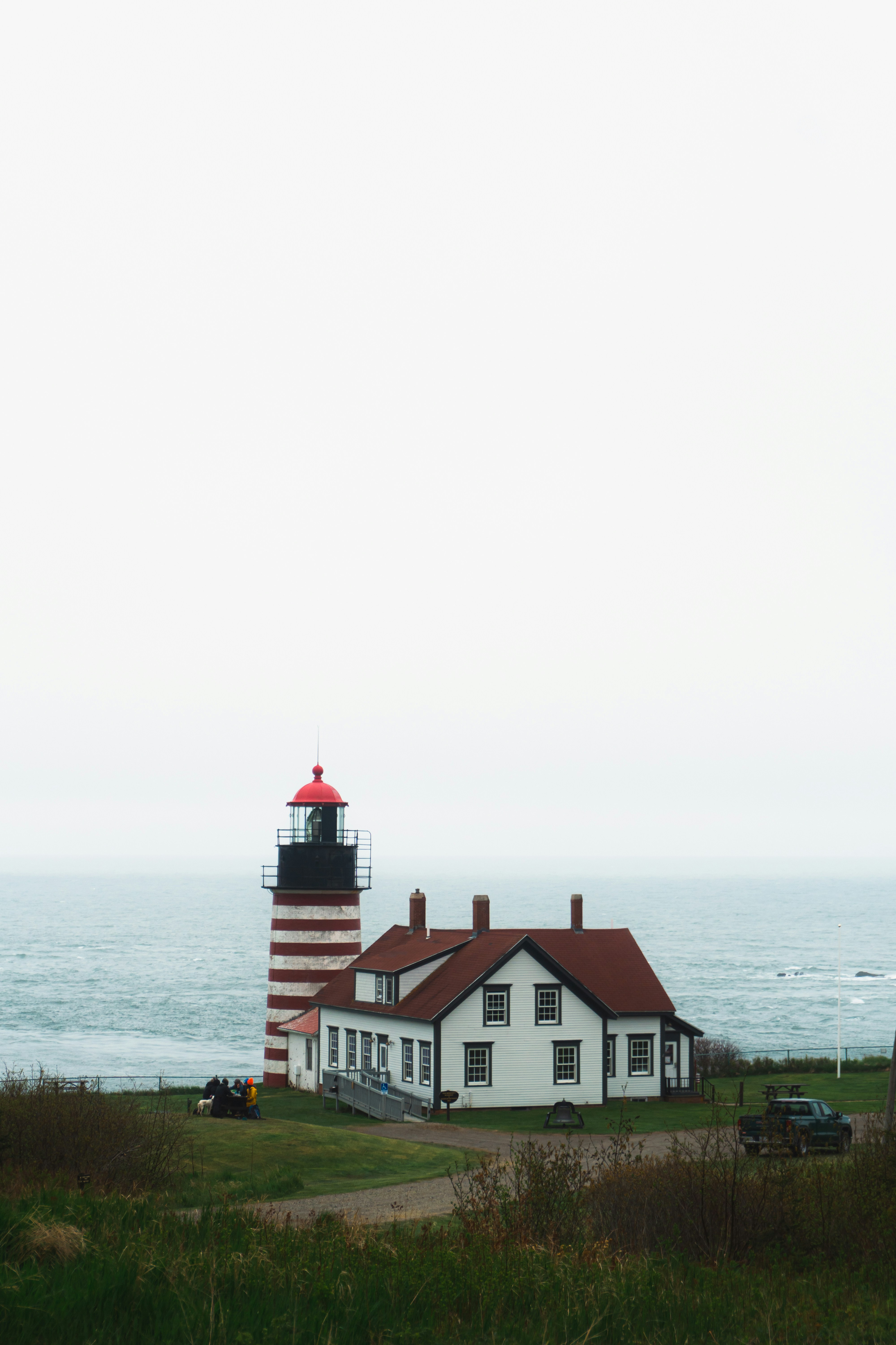 A lighthouse by the water photo – Free Wallpaper Image on Unsplash
