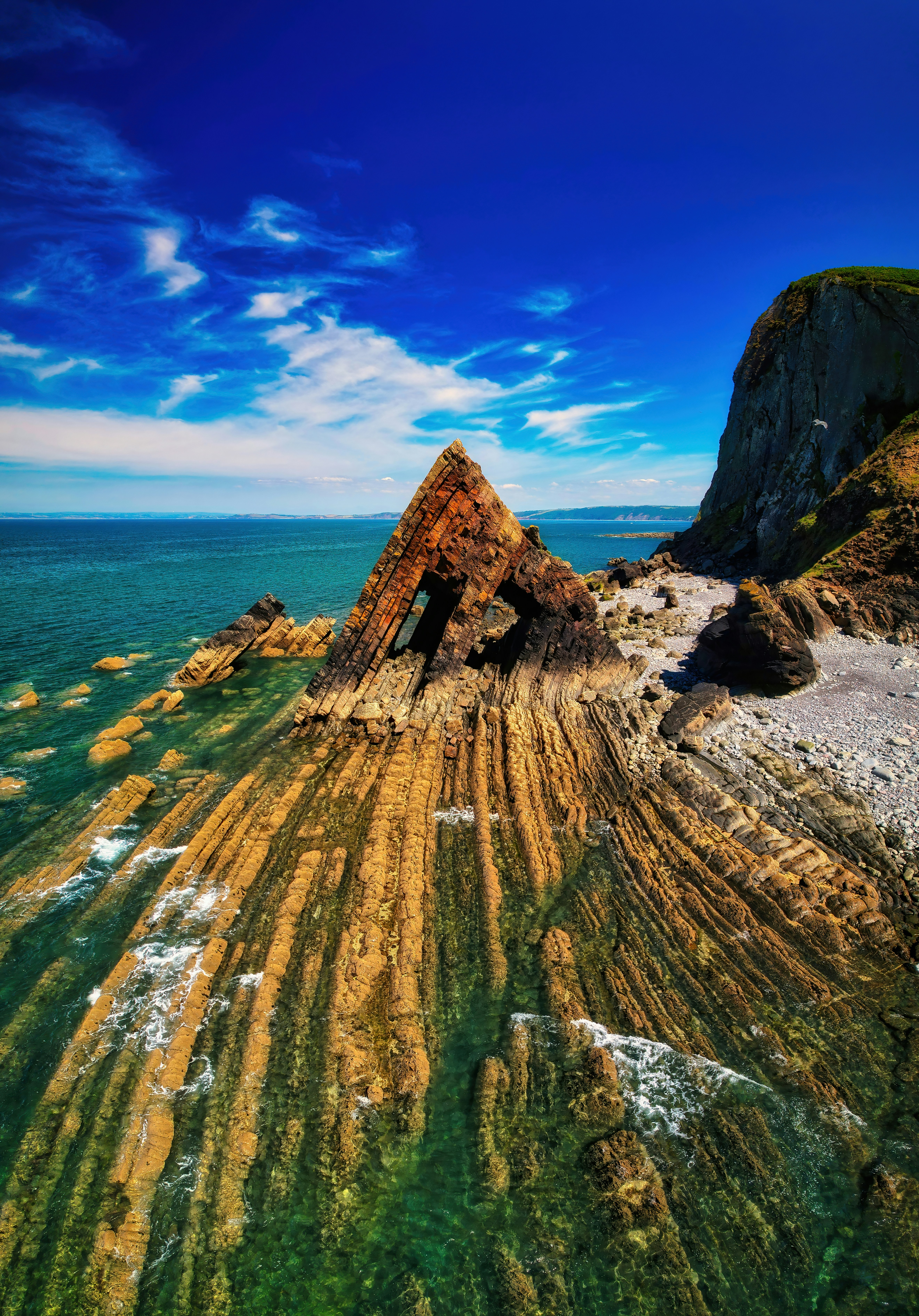 Rock Spine at the Edge: Striated Promontory Reaching Toward the Open Sea