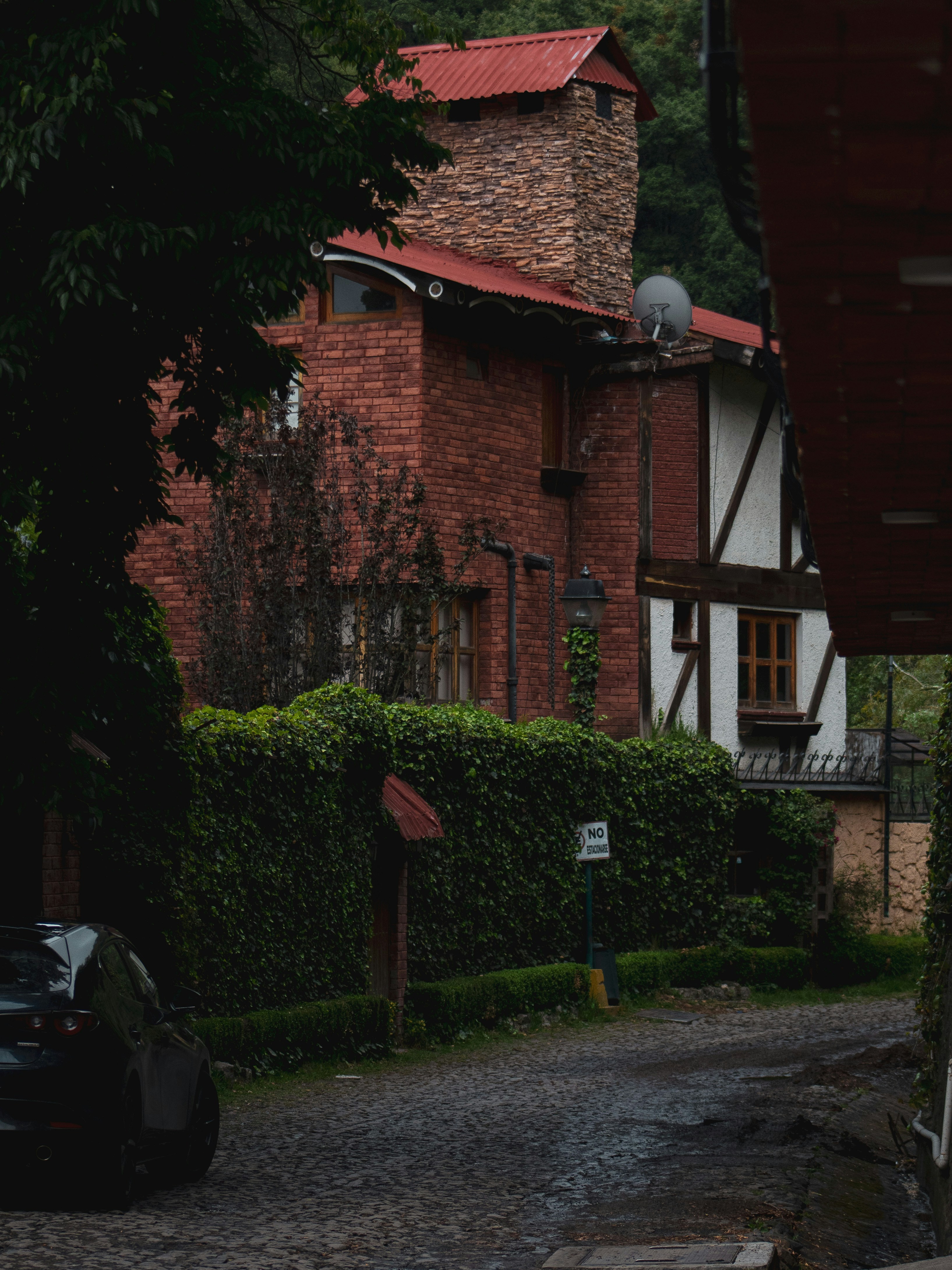 Cobbled Lane Between Brick and Timbered Homes
