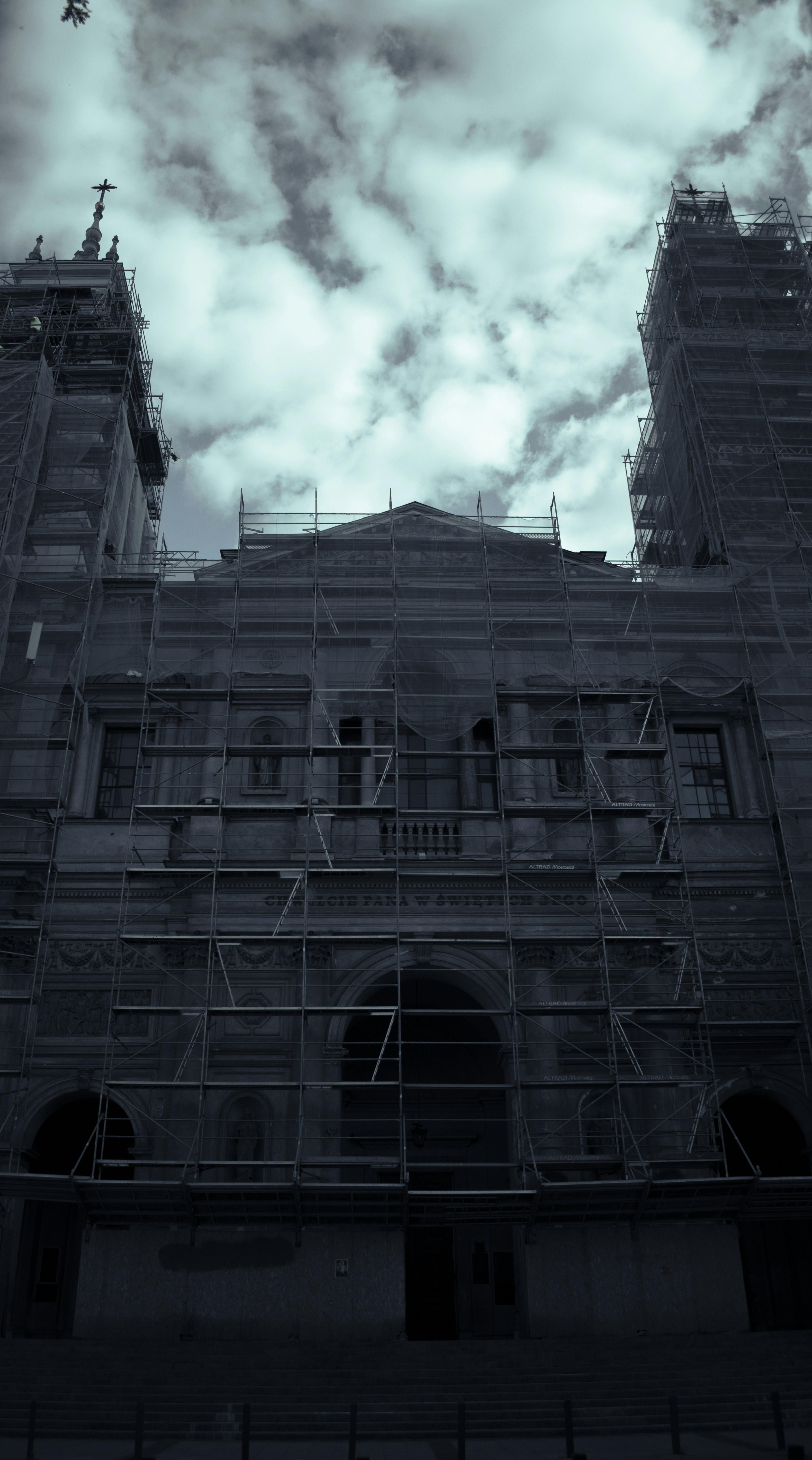 Facades in Scaffolding: A Cathedral Rebuilt Beneath Cloudy Skies