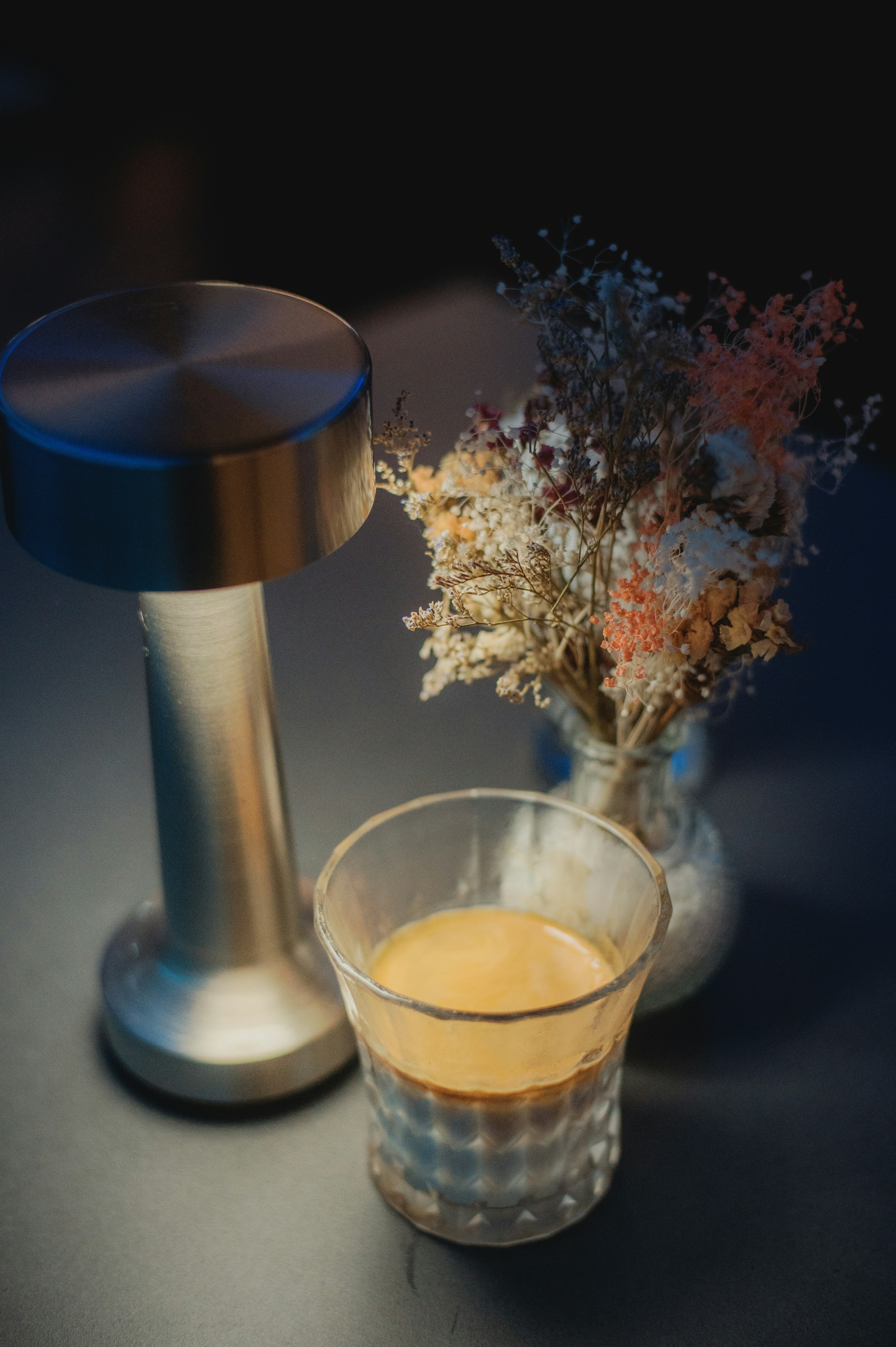 hot coffee on a table with cream being poured into it showing the texture